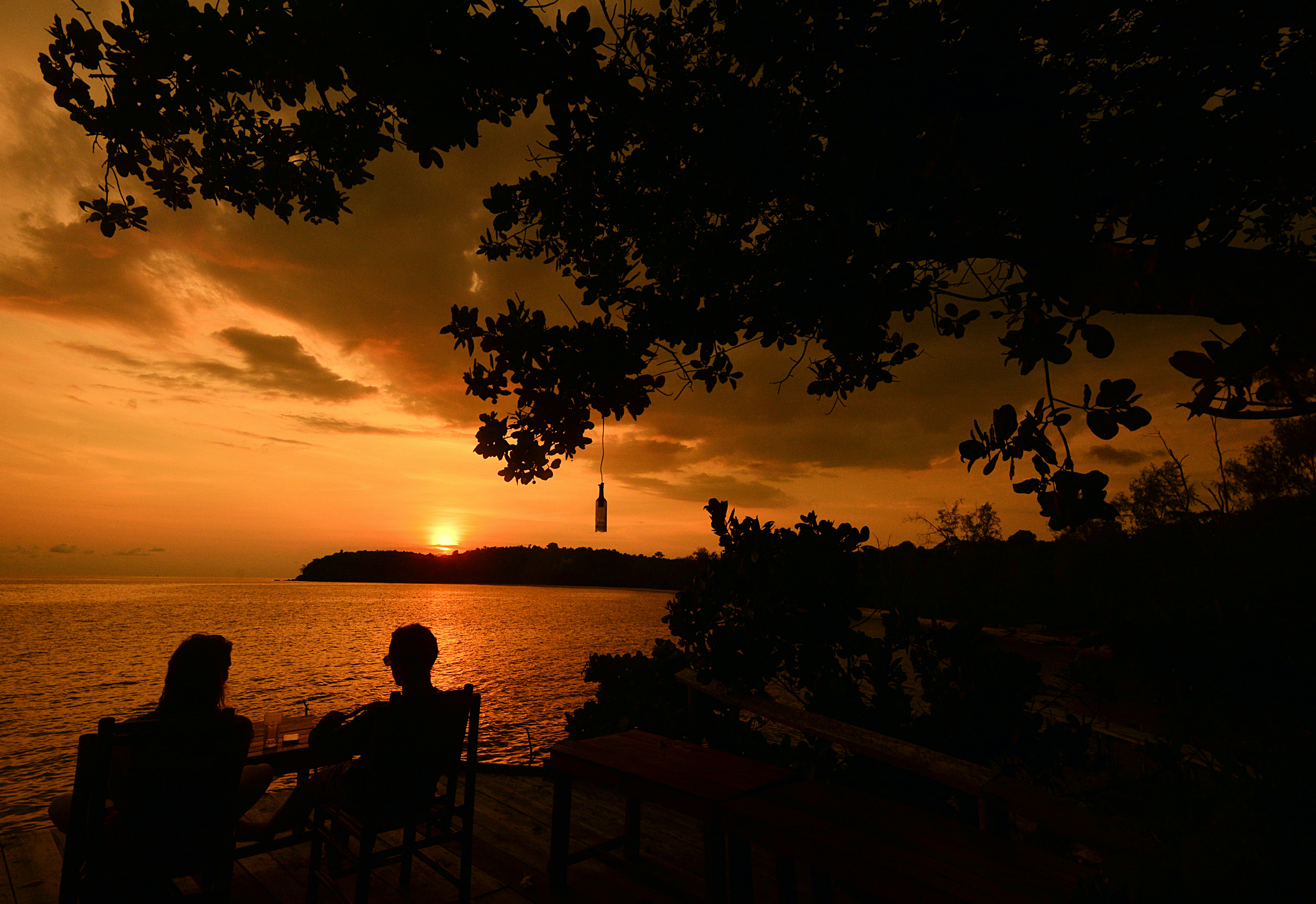 Two people sitting on a bench watching the sunset photo – Free Cambodia ...