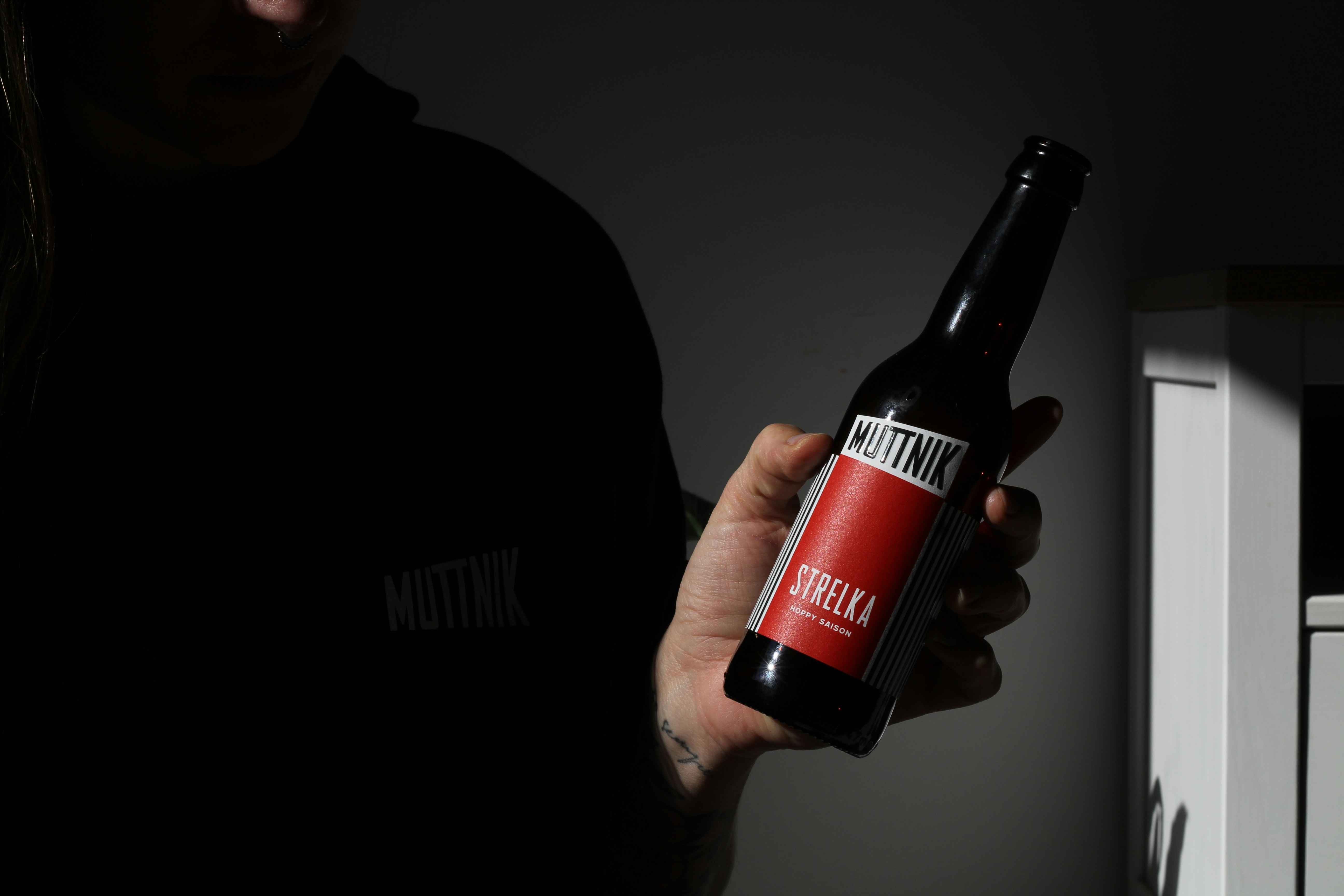 Bottle of Mutnik: Red Label in a Dim Studio