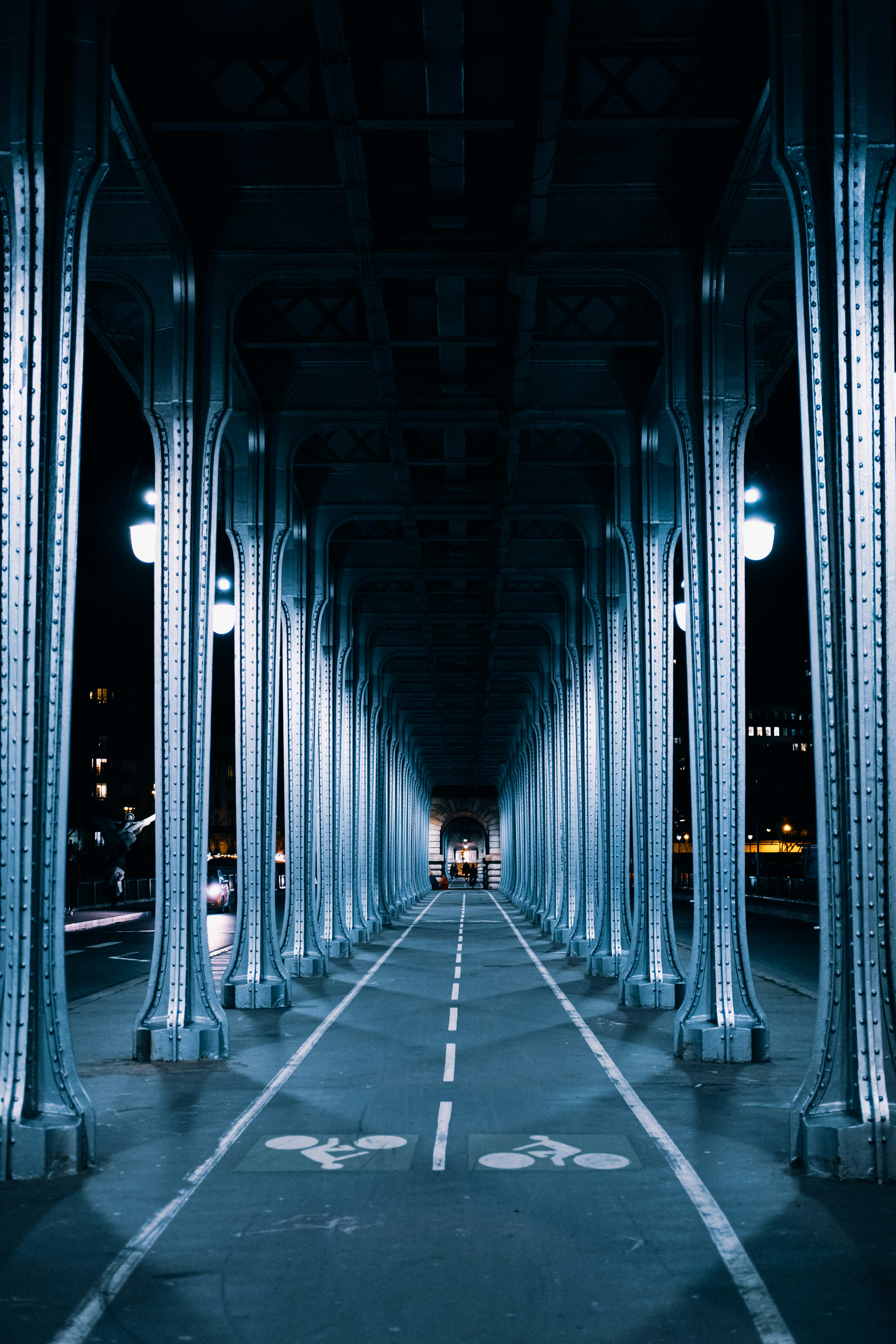 A long walkway with columns and street lights photo – Free Paris Image ...