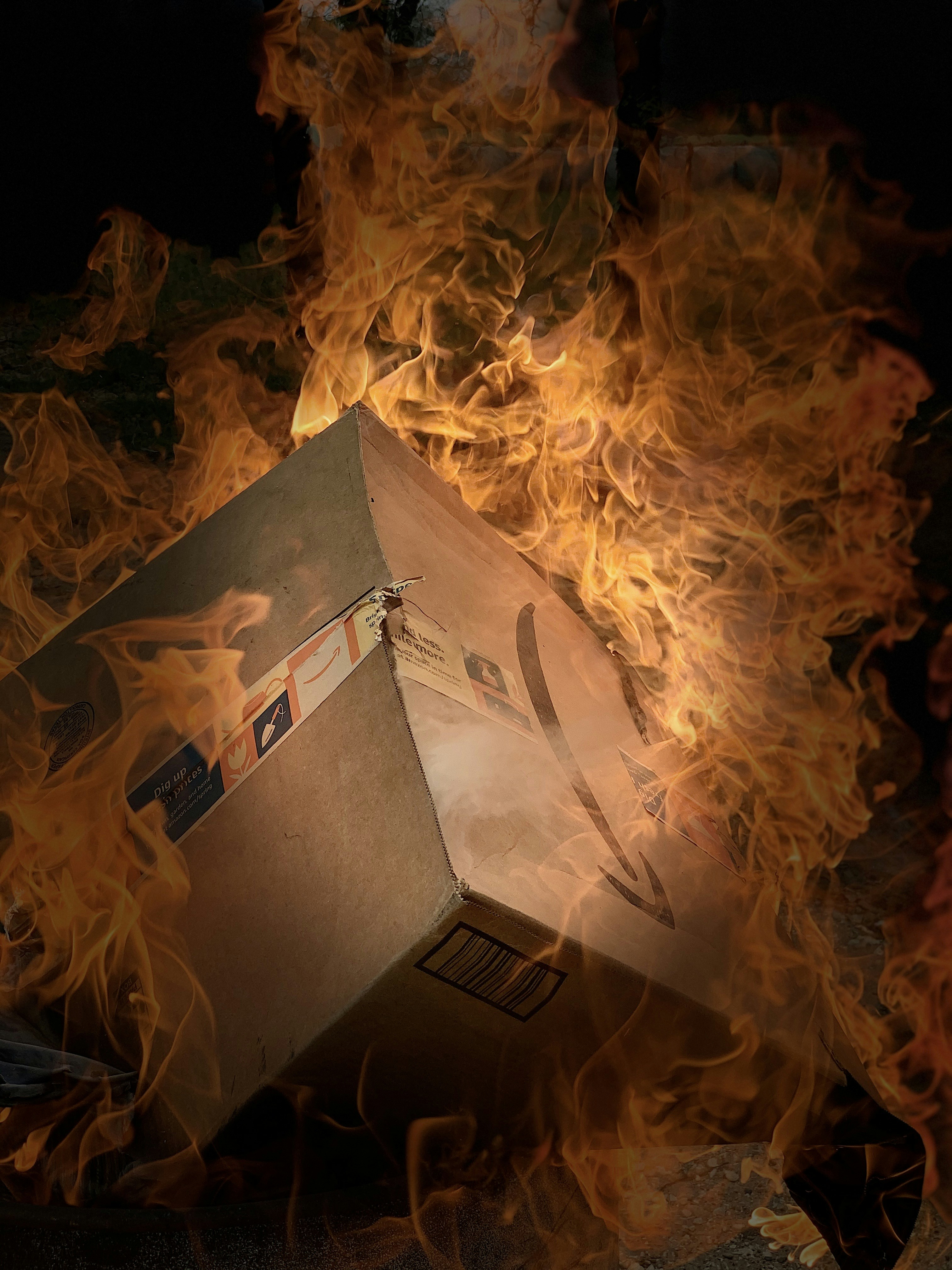 Box on fire: cardboard package ignites amid orange flames