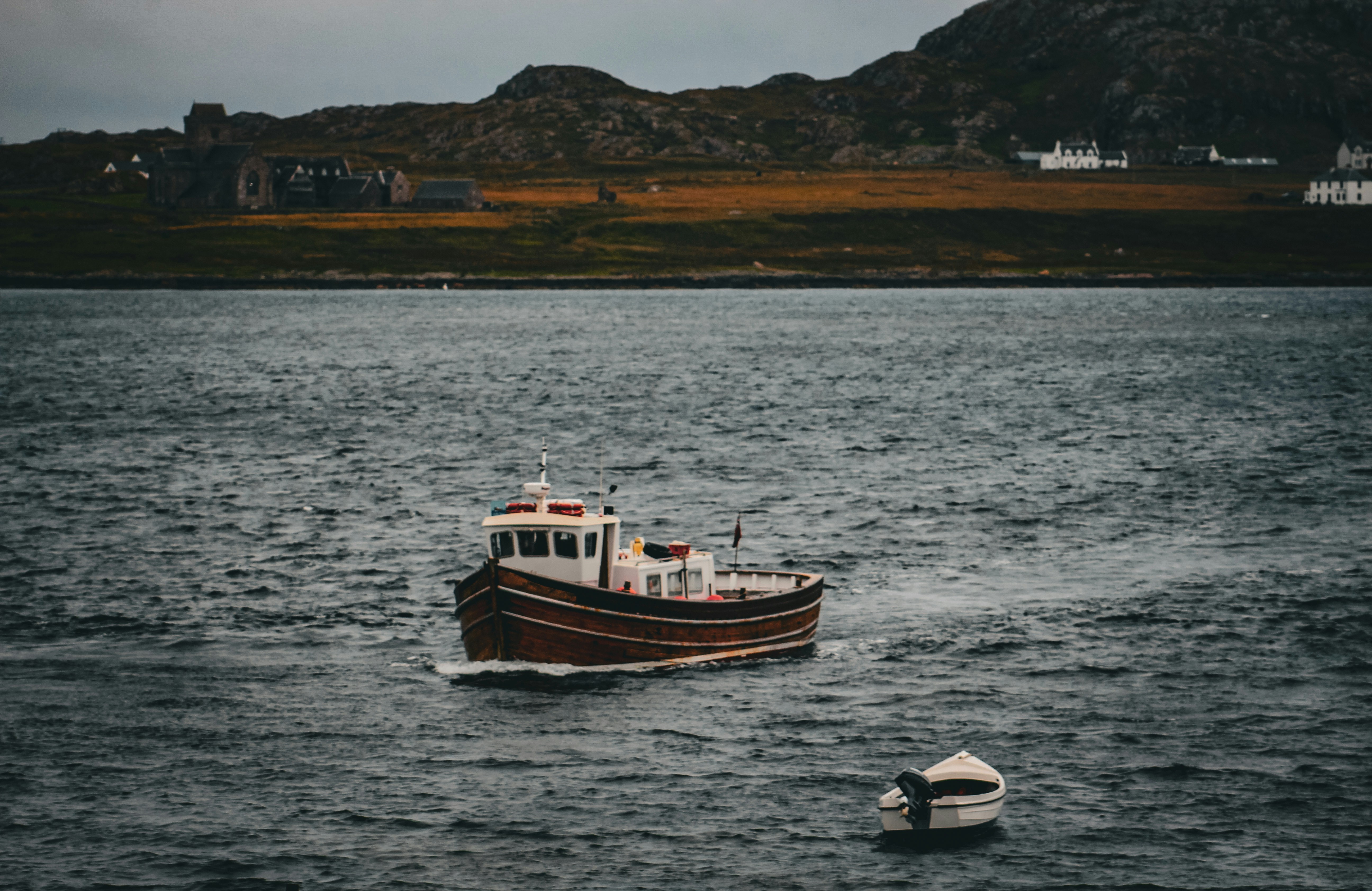a small boat traveling across a large body of water
