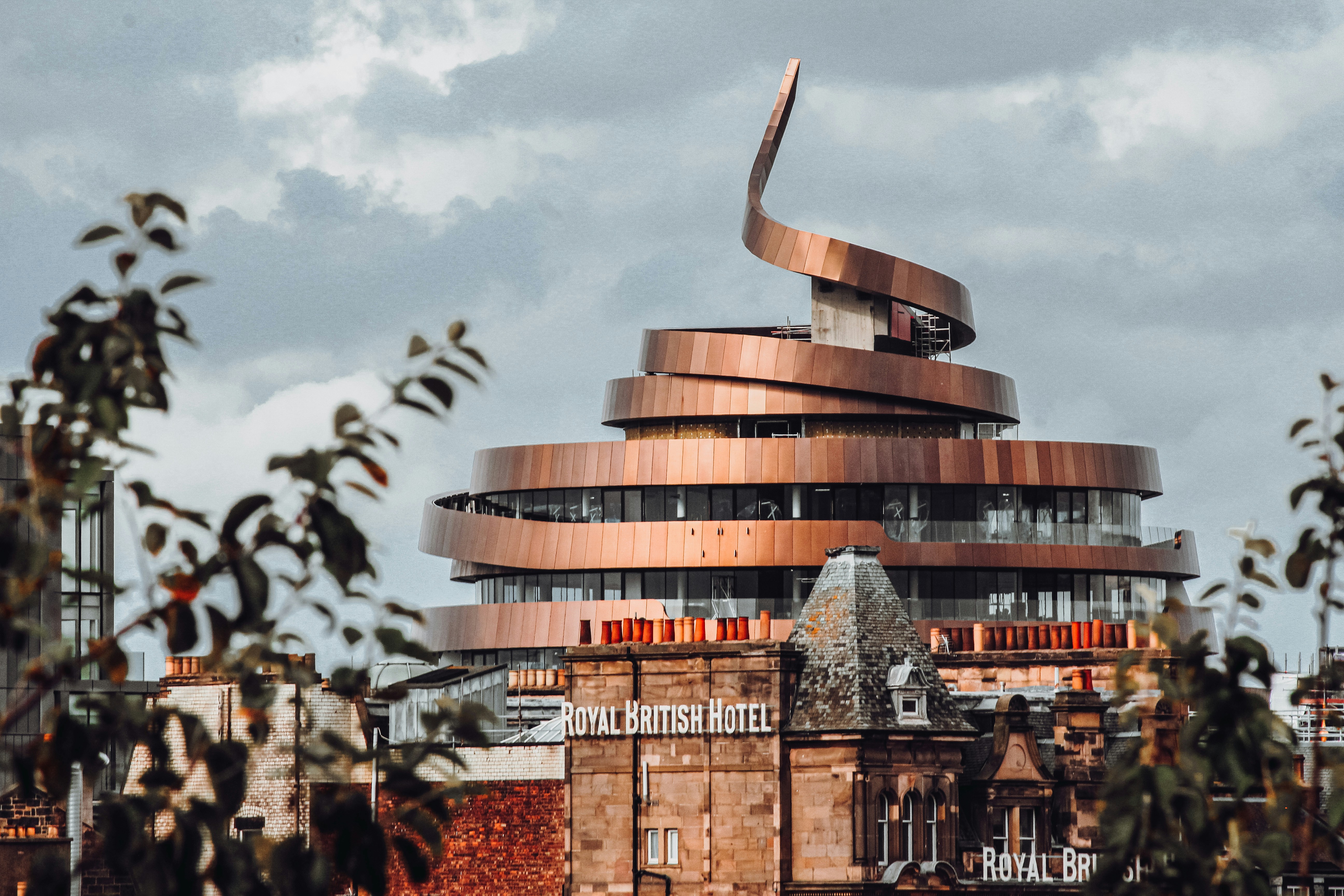 A large building with a spiral design on top of it photo – Free ...