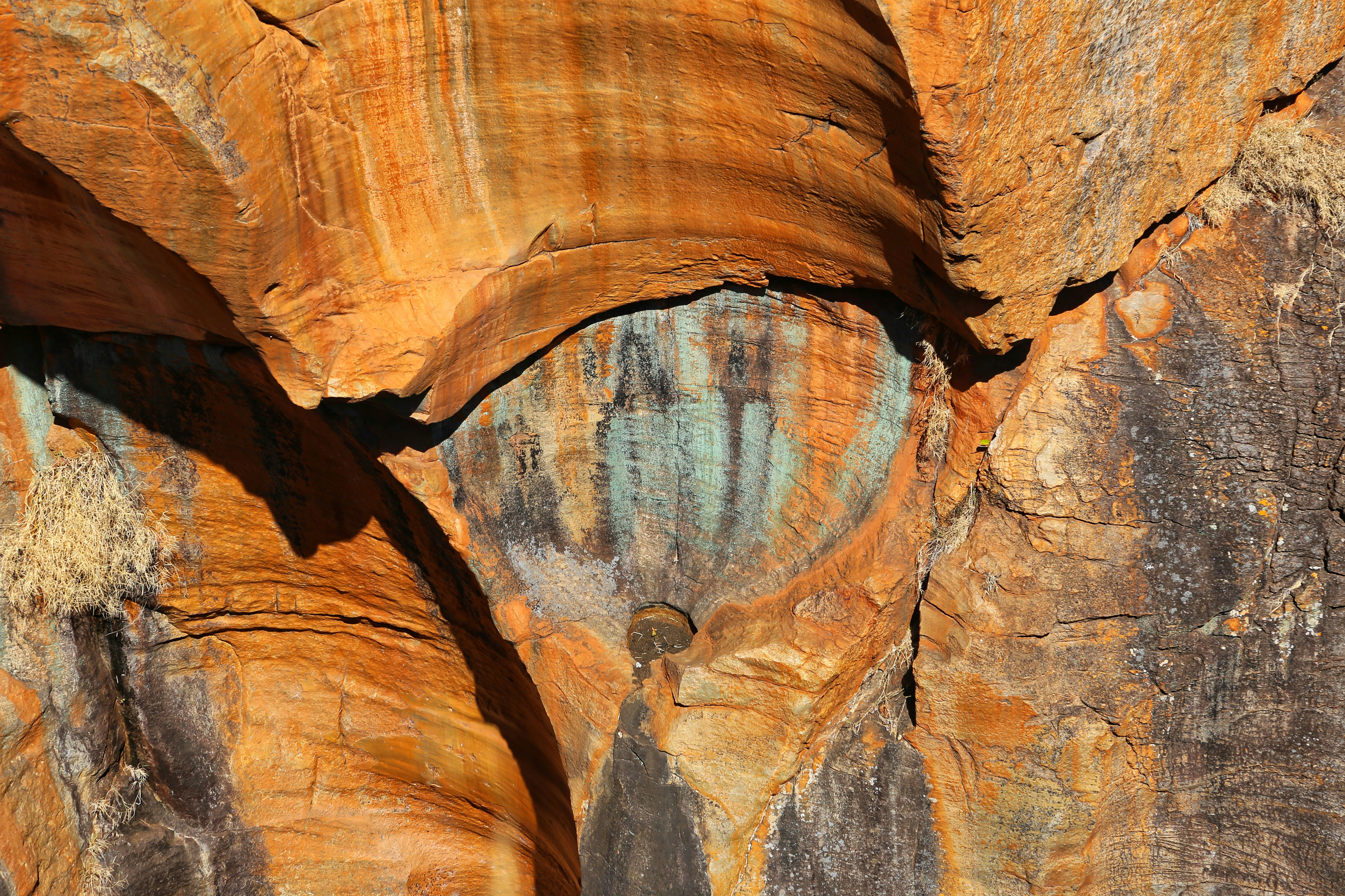 Intricate layers of orange and blue rock formations revealing the natural artistry of erosion and time.