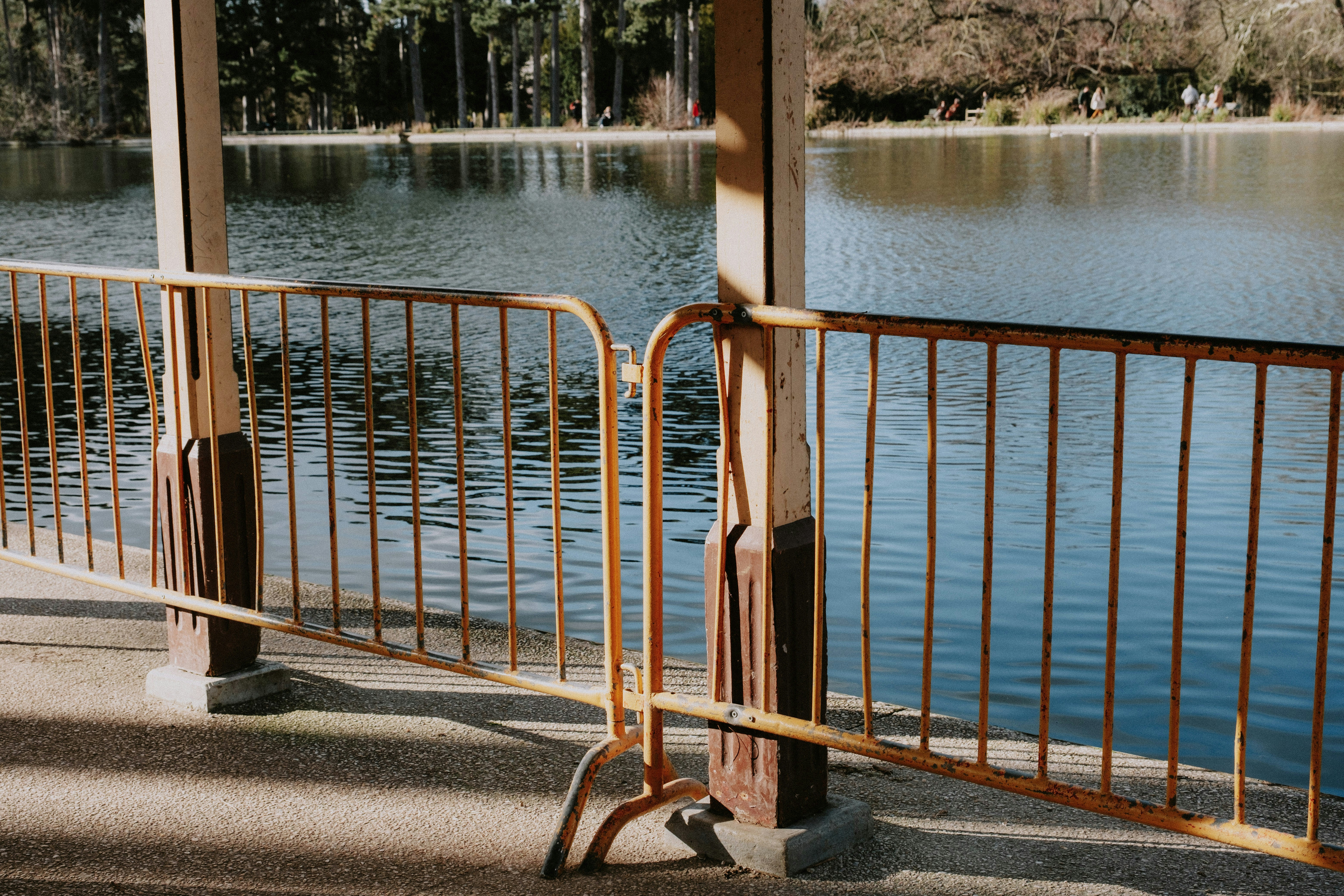 Amber Rails Frame a Quiet Lakeside Walkway