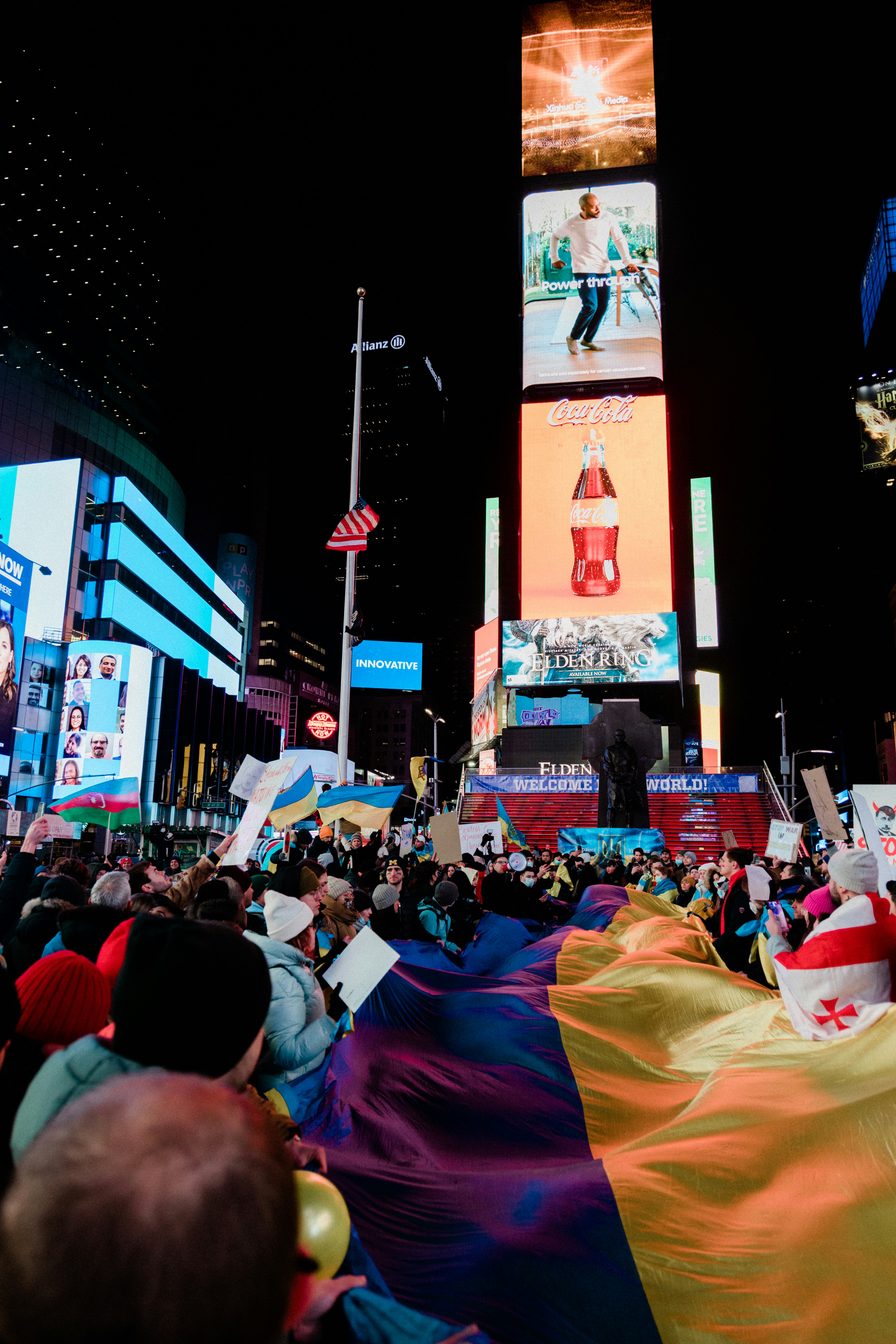 City of Light and Flags: Crowds Rally Under Digital Monoliths