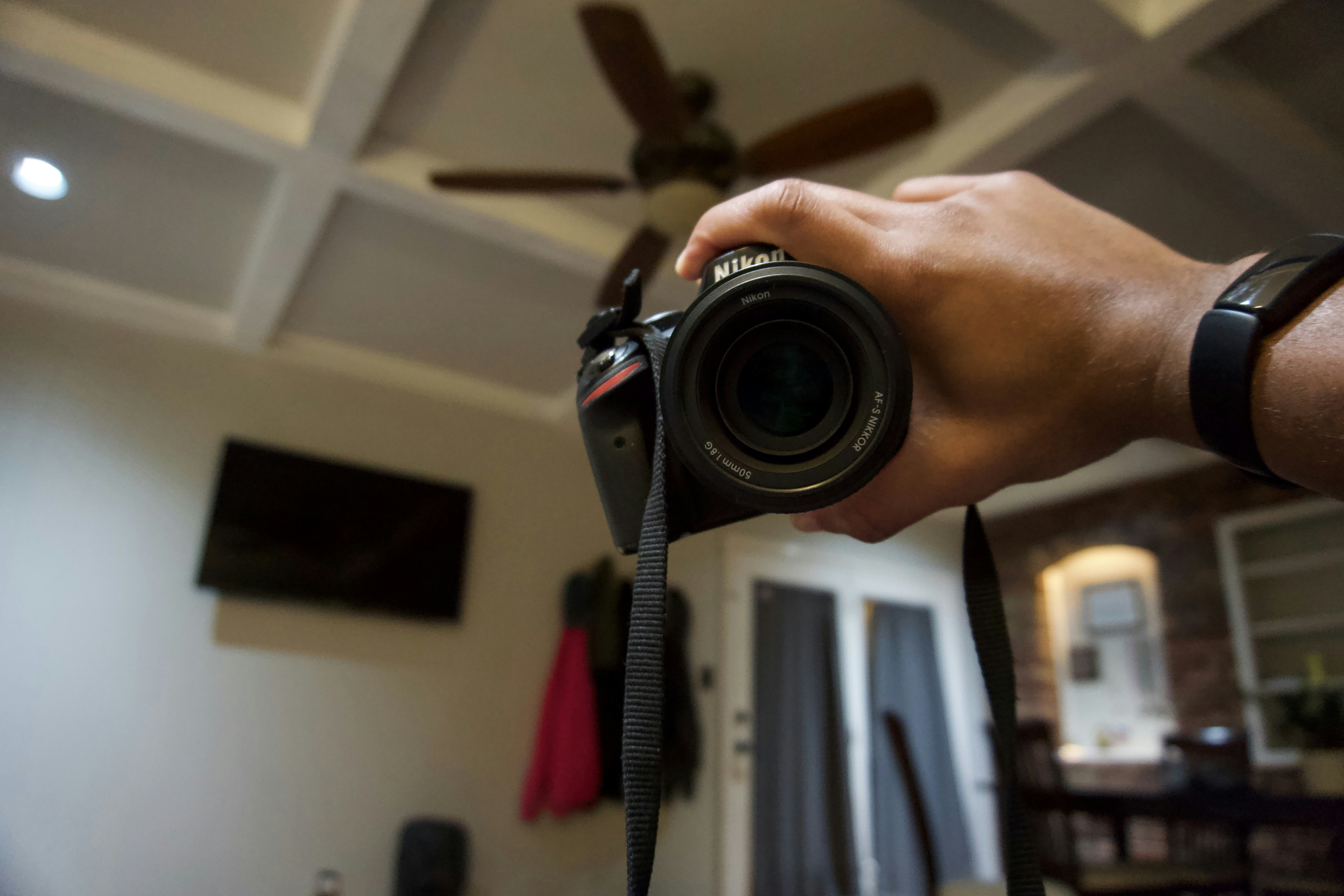 Hand-Held Focus: A Nikon in a Cozy Indoor Frame