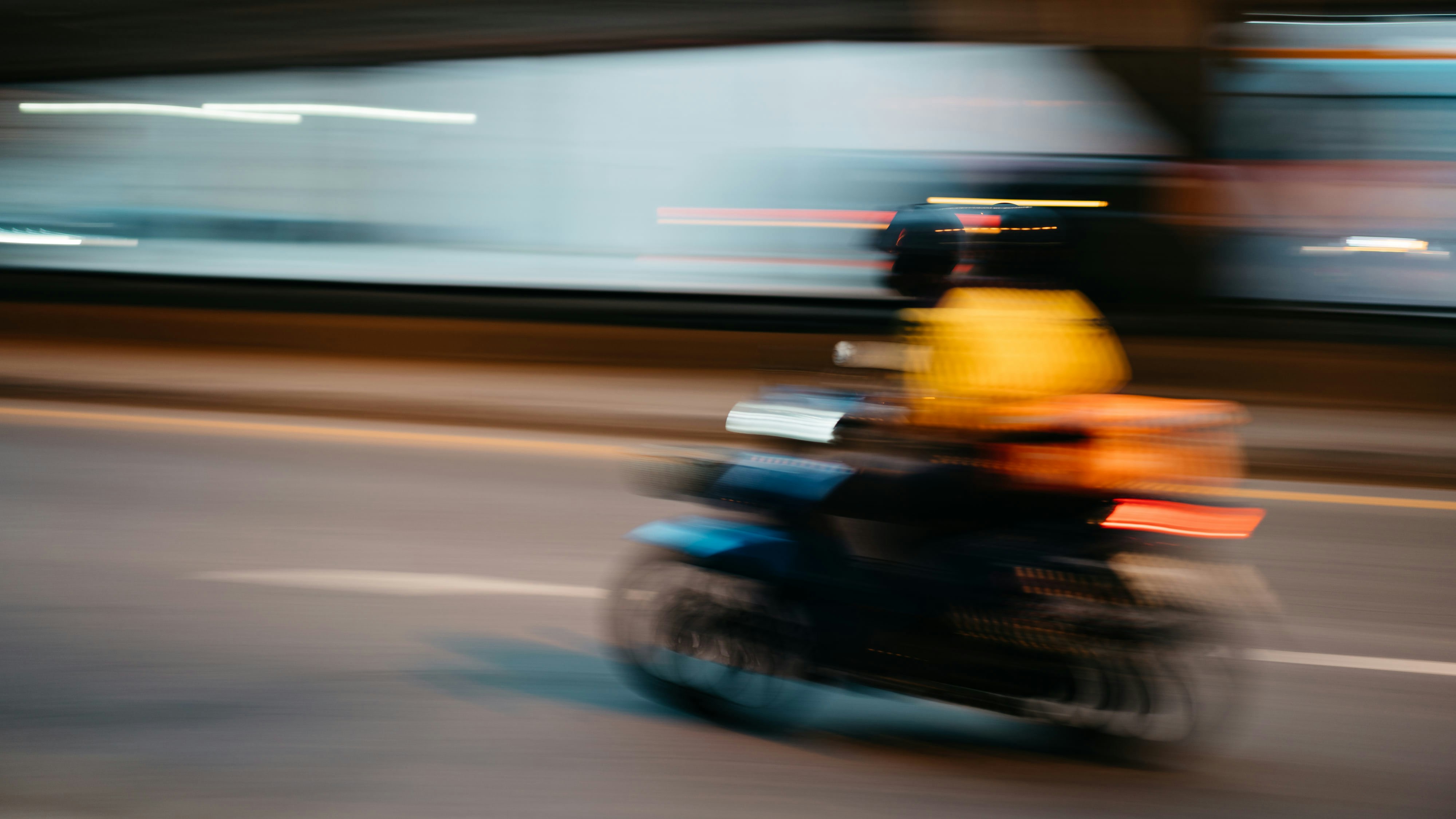 A blurry photo of a person riding a motorcycle photo – Free Bangkok ...