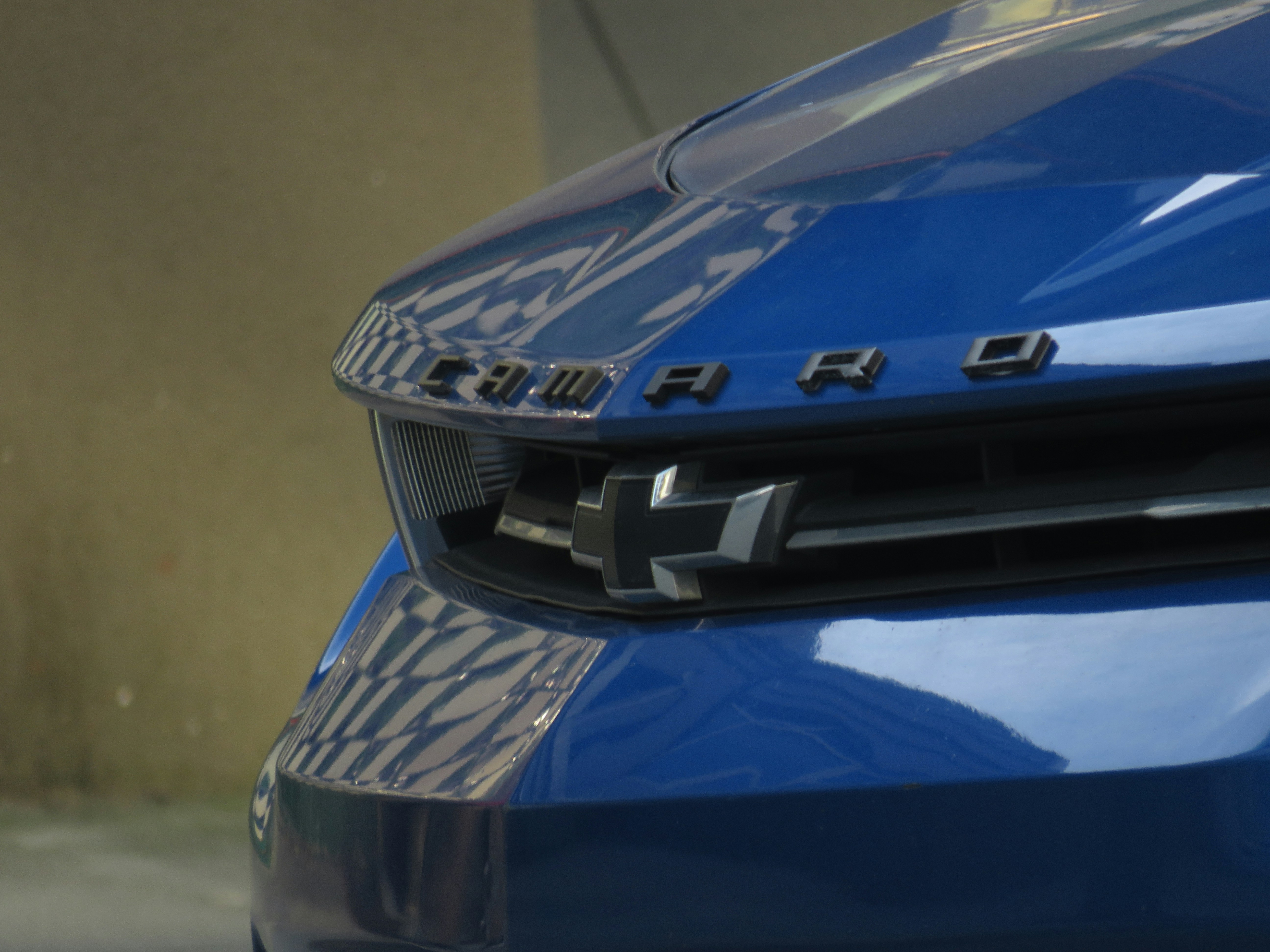 a close up of the front of a blue car