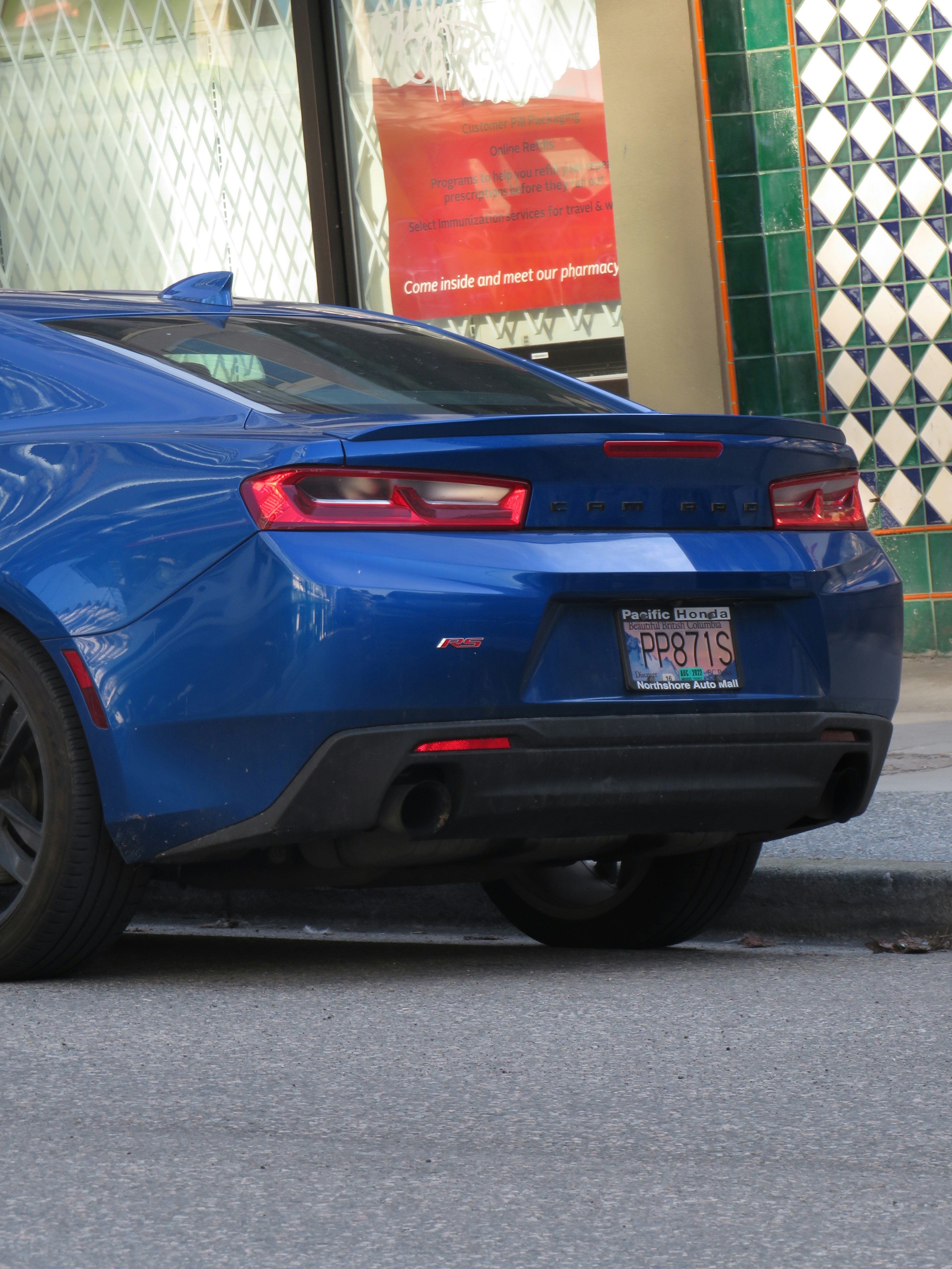 Chrome-Bodied Blue: A Rear View of a Sports Coupe in Urban Evening Light
