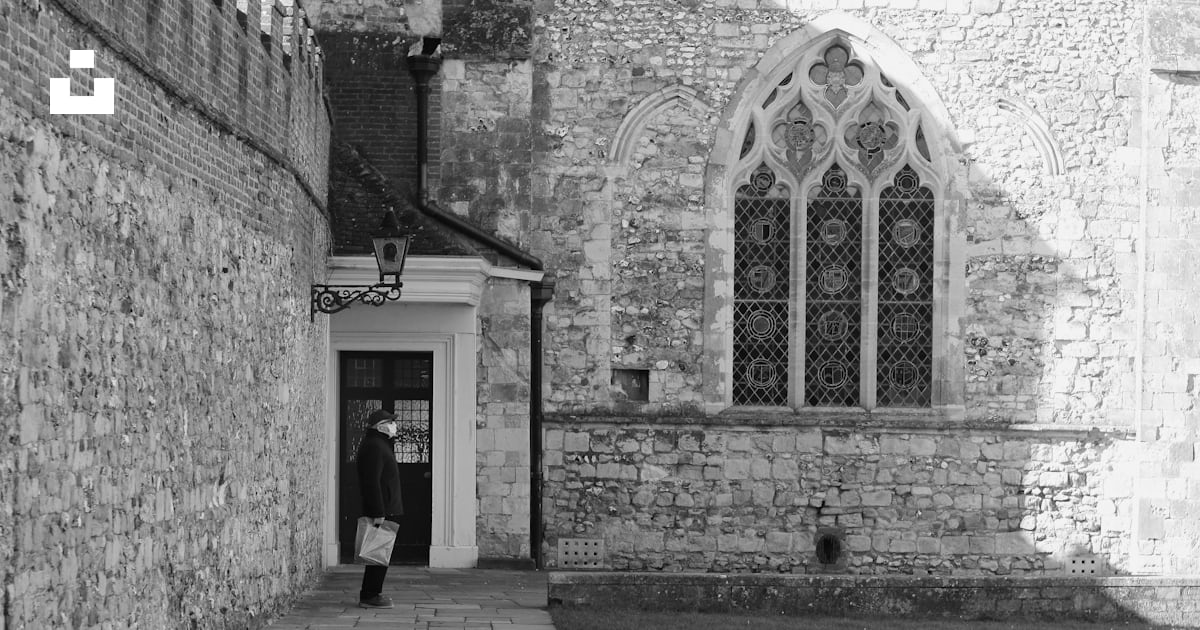 A Black And White Photo Of A Man Entering A Church Photo Free Chichester Cathedral Image On