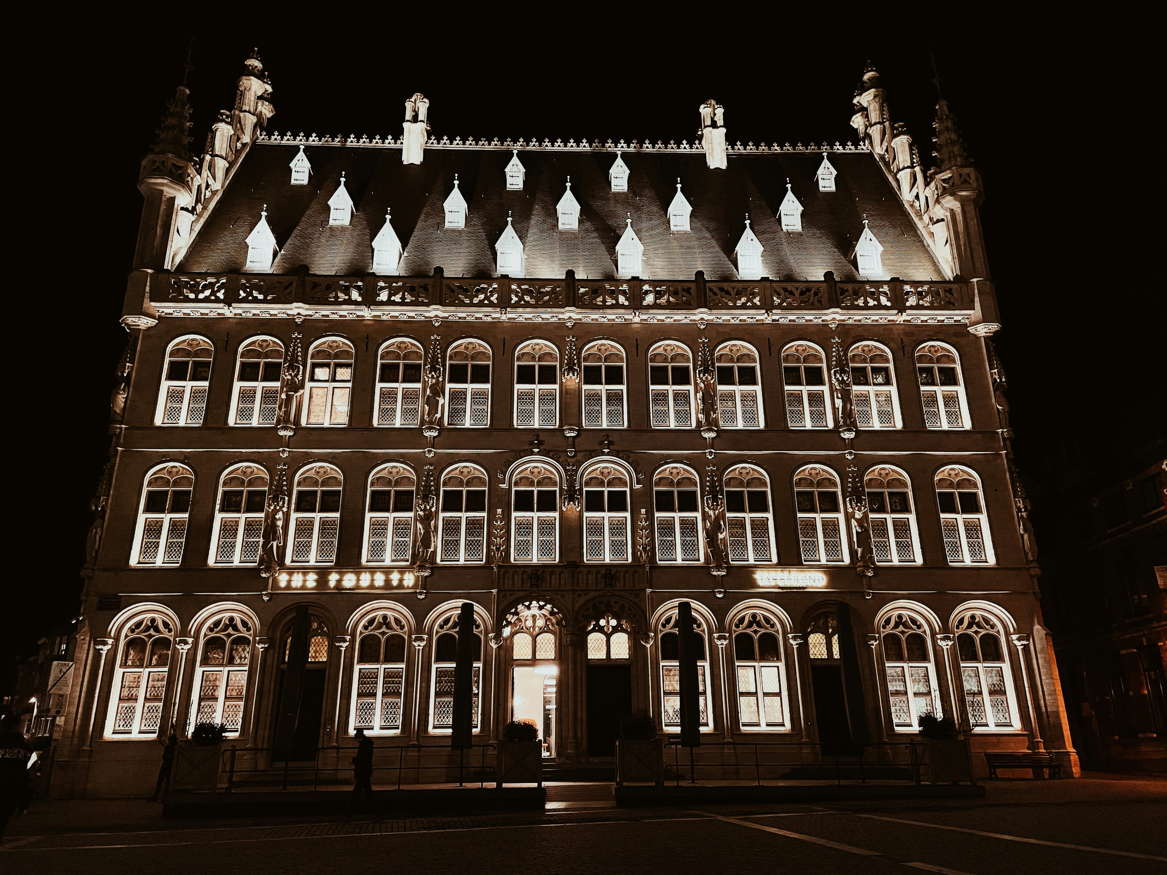 Historic building with ornate architectural details illuminated against the night sky.