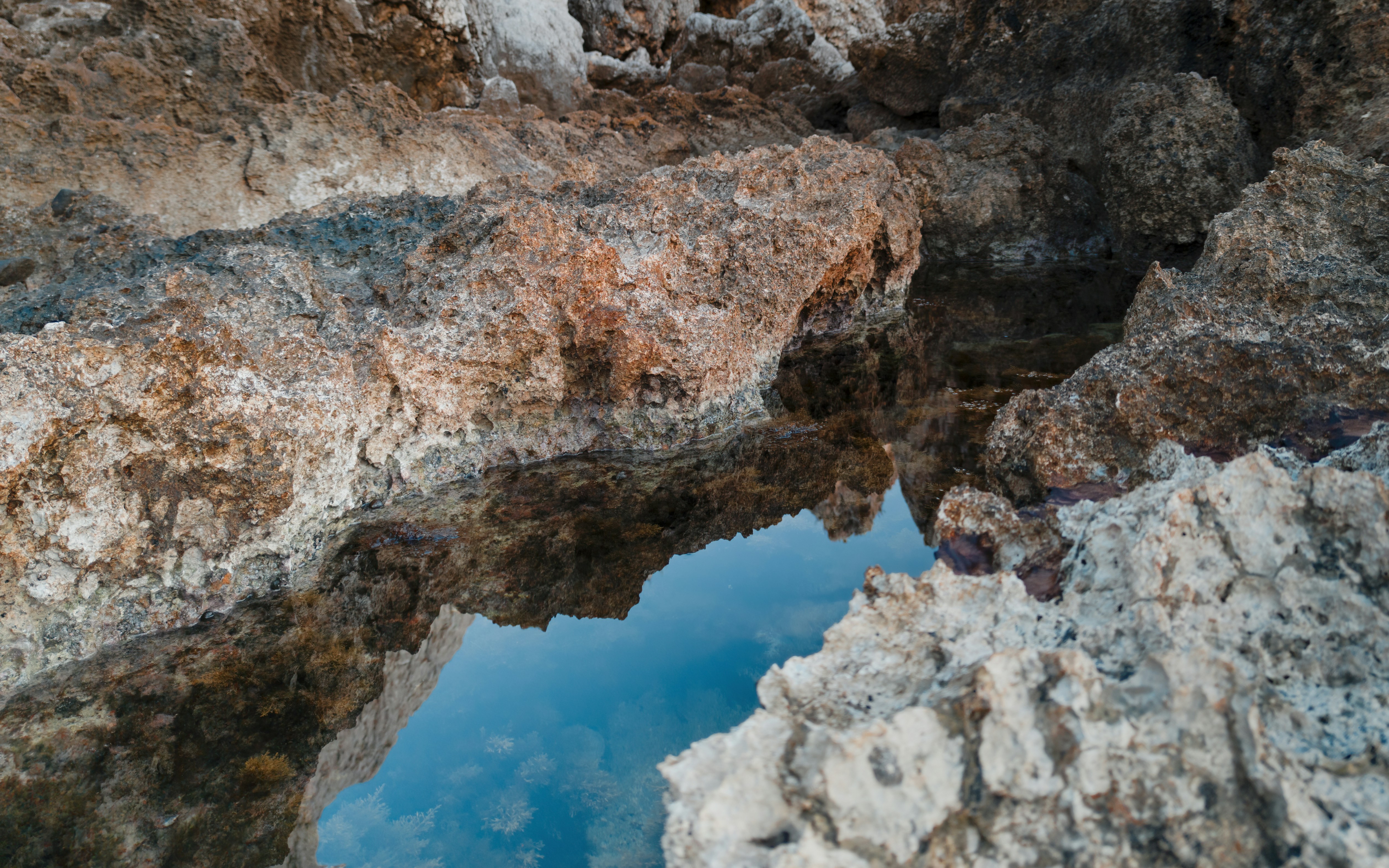 A small pool of water surrounded by rocks photo – Free Italia Image on ...
