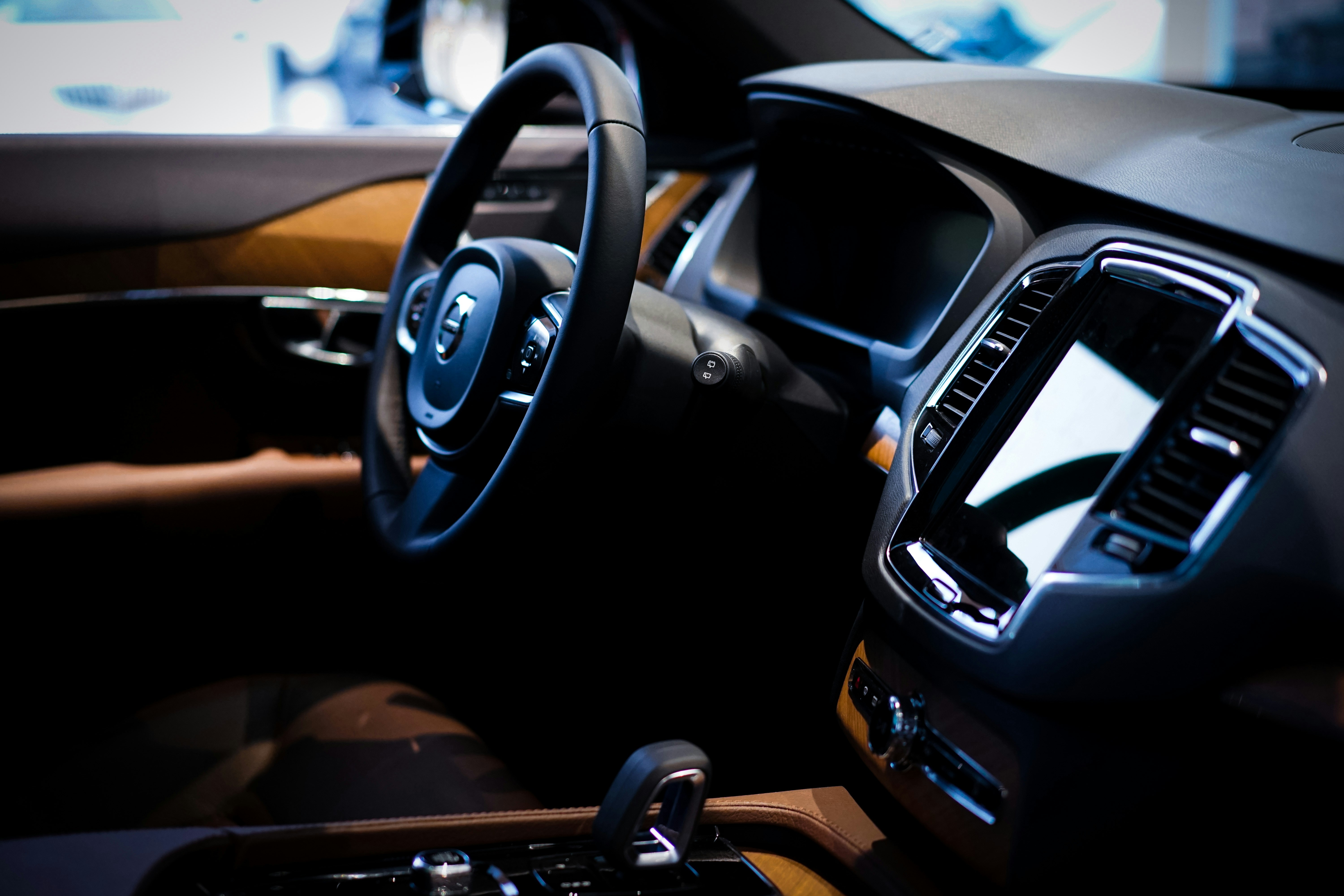 Luxurious car interior showcasing a sleek dashboard, modern controls, and sophisticated materials. The design emphasizes comfort and advanced technology.