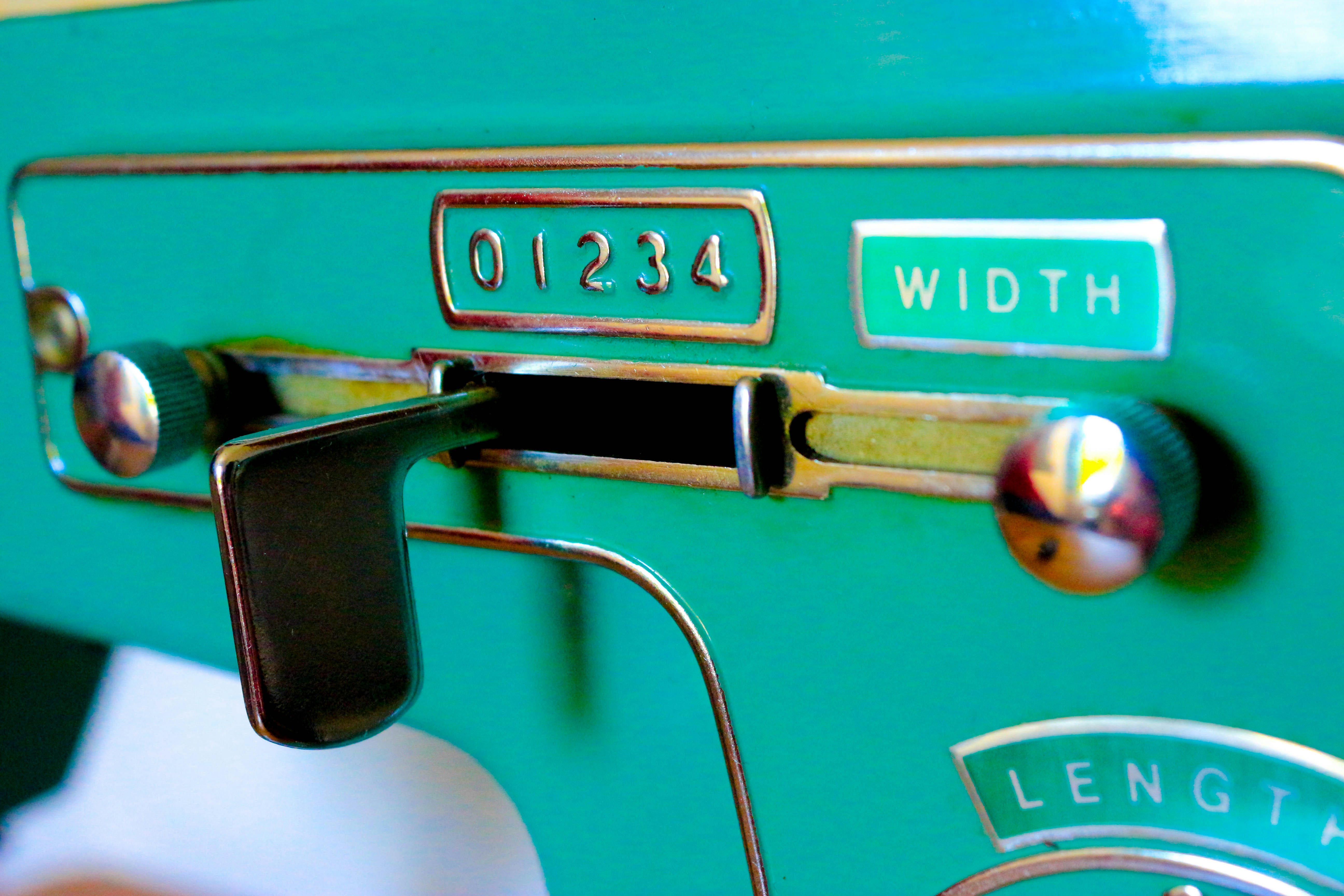 A close up of a green machine with a metal handle photo – Free numbers ...