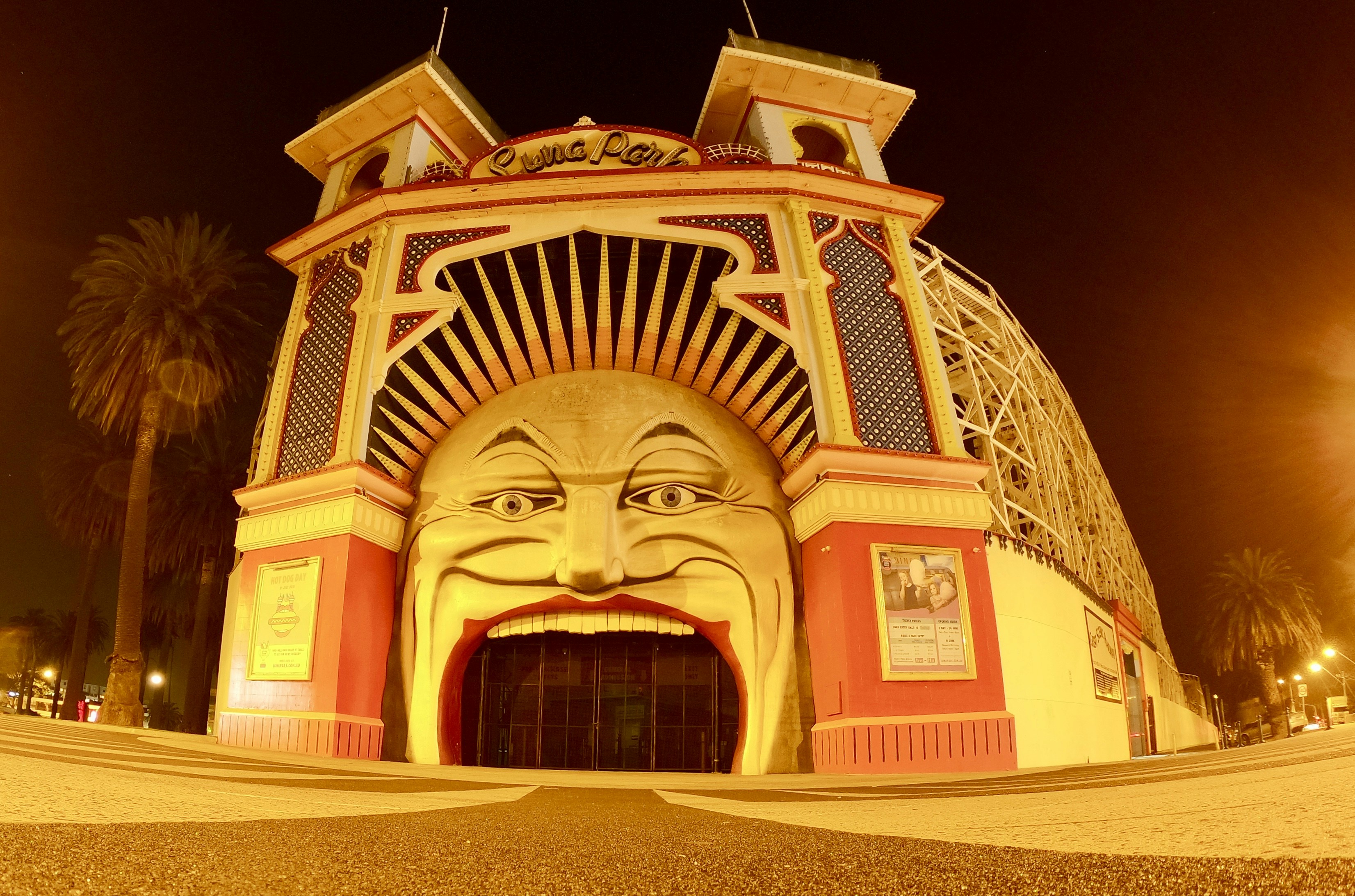 A large building with a giant face on it photo – Free Amusement park ...