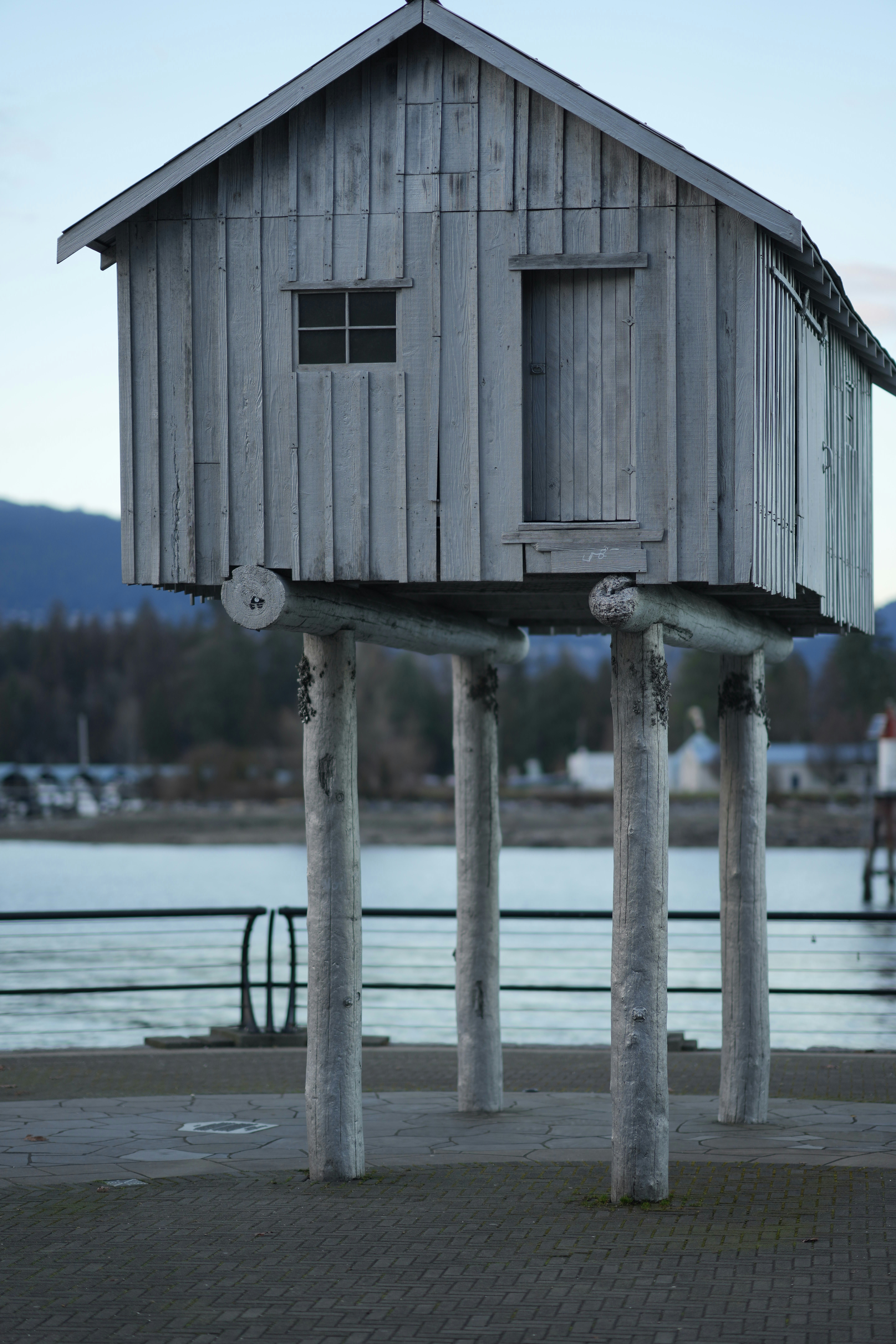 a wooden structure sitting on the side of a body of water