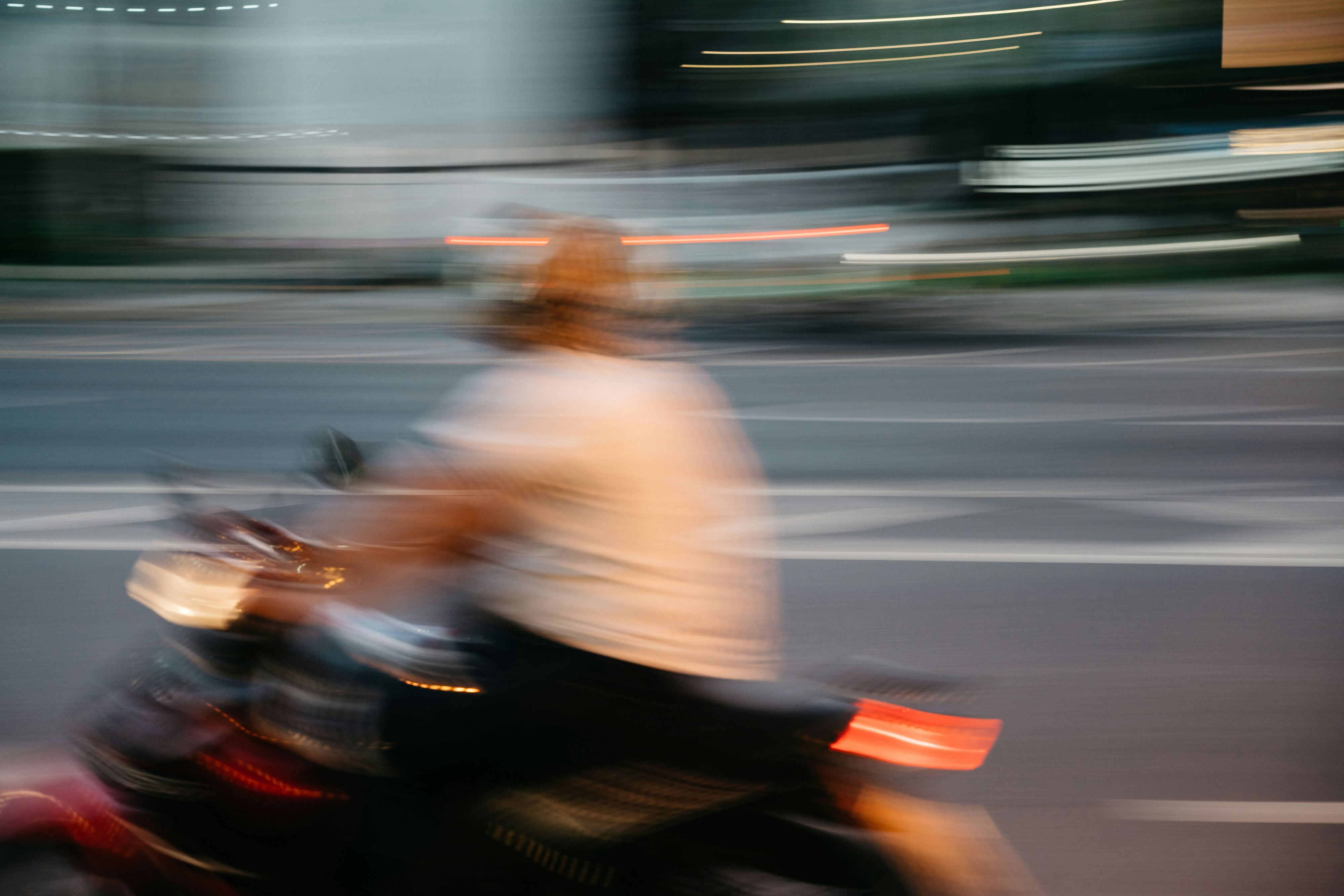 A blurry photo of a man riding a motorcycle photo – Free Brown Image on ...