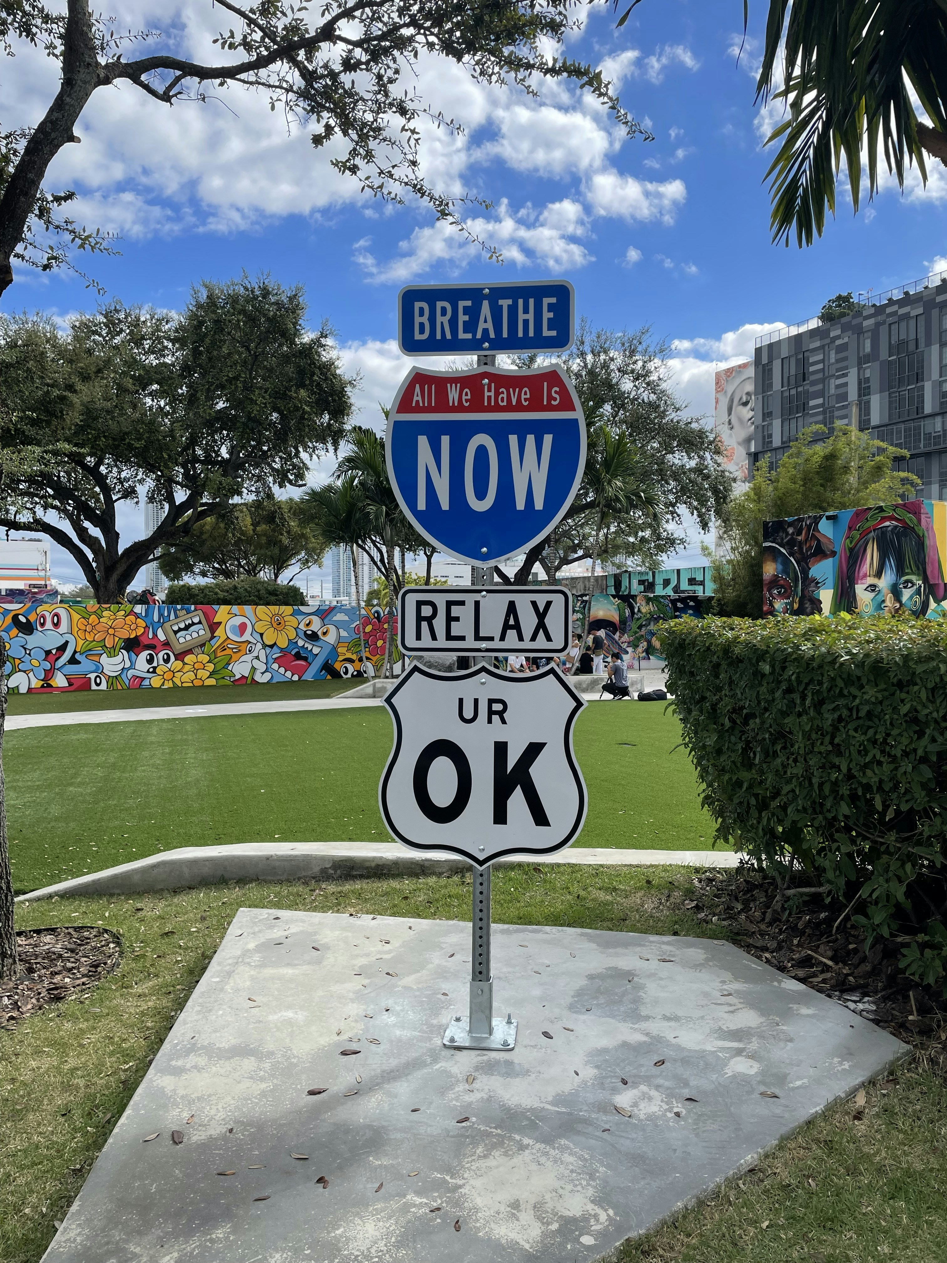 Breathe Now: A Signpost of Words Over a Graffiti Garden