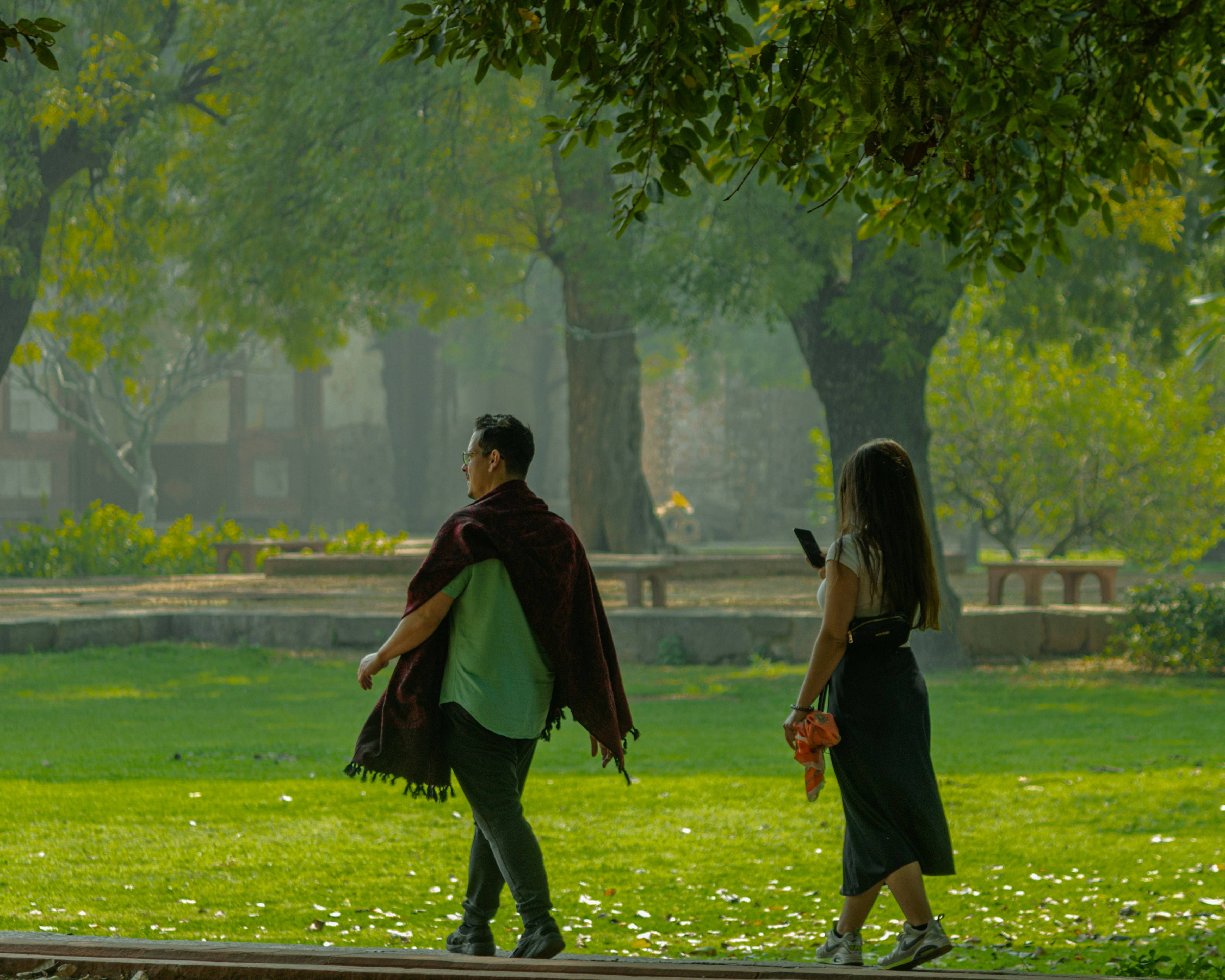 Quiet Park Stroll: Two Figures in Soft Morning Light