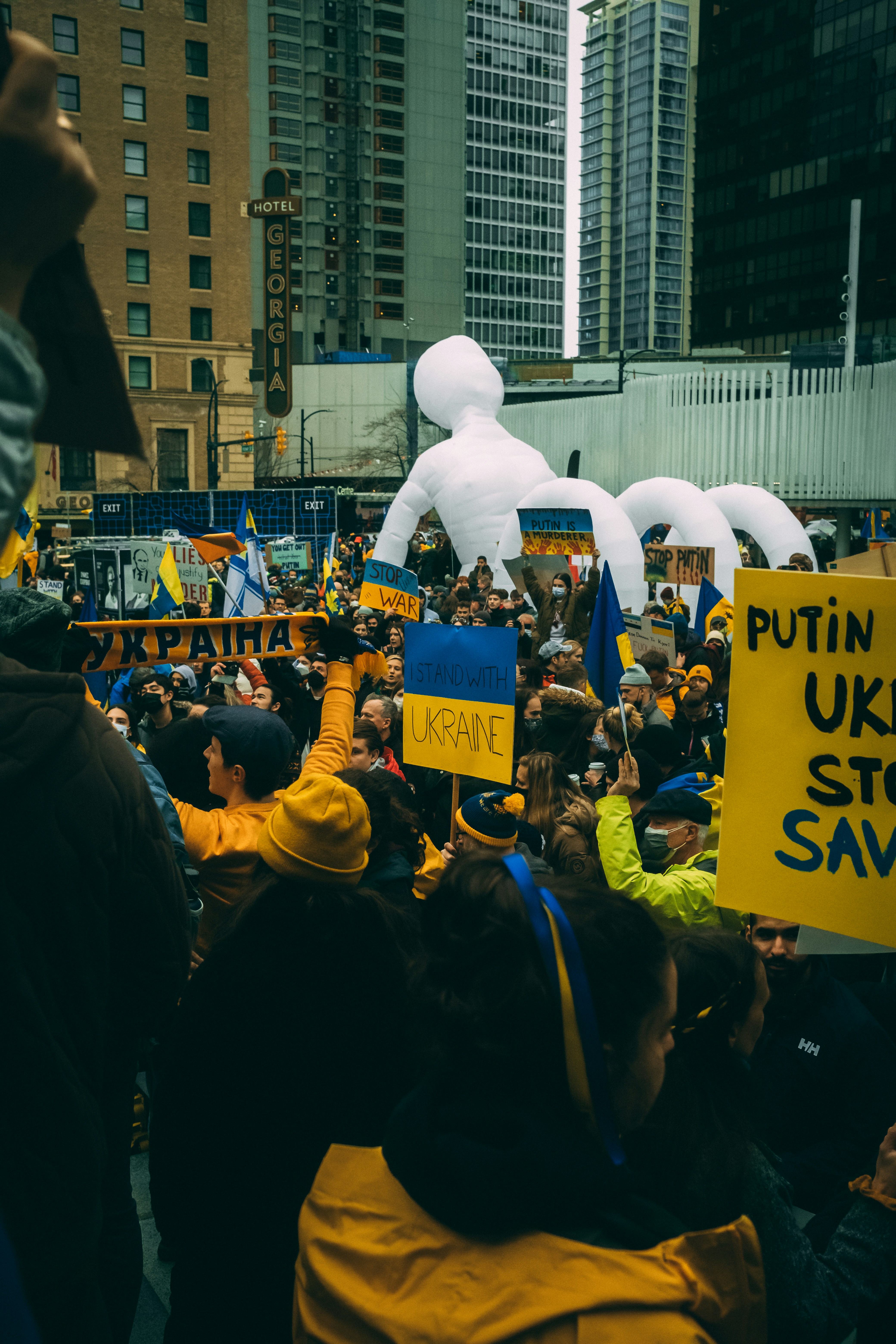 A crowd of people holding signs in the street photo – Free Vancouver ...