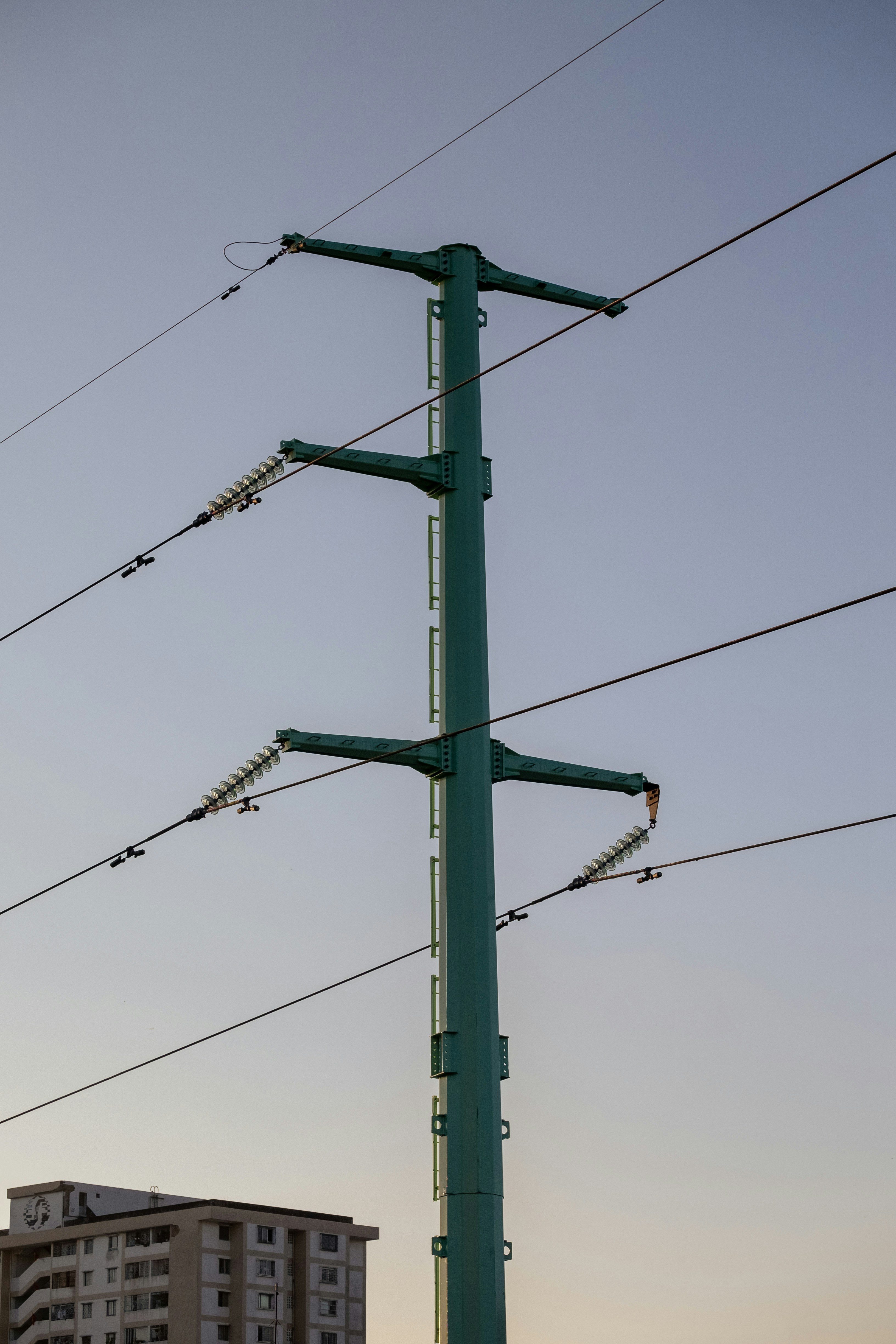 A tall green pole sitting next to a tall building photo – Free Ho chi ...