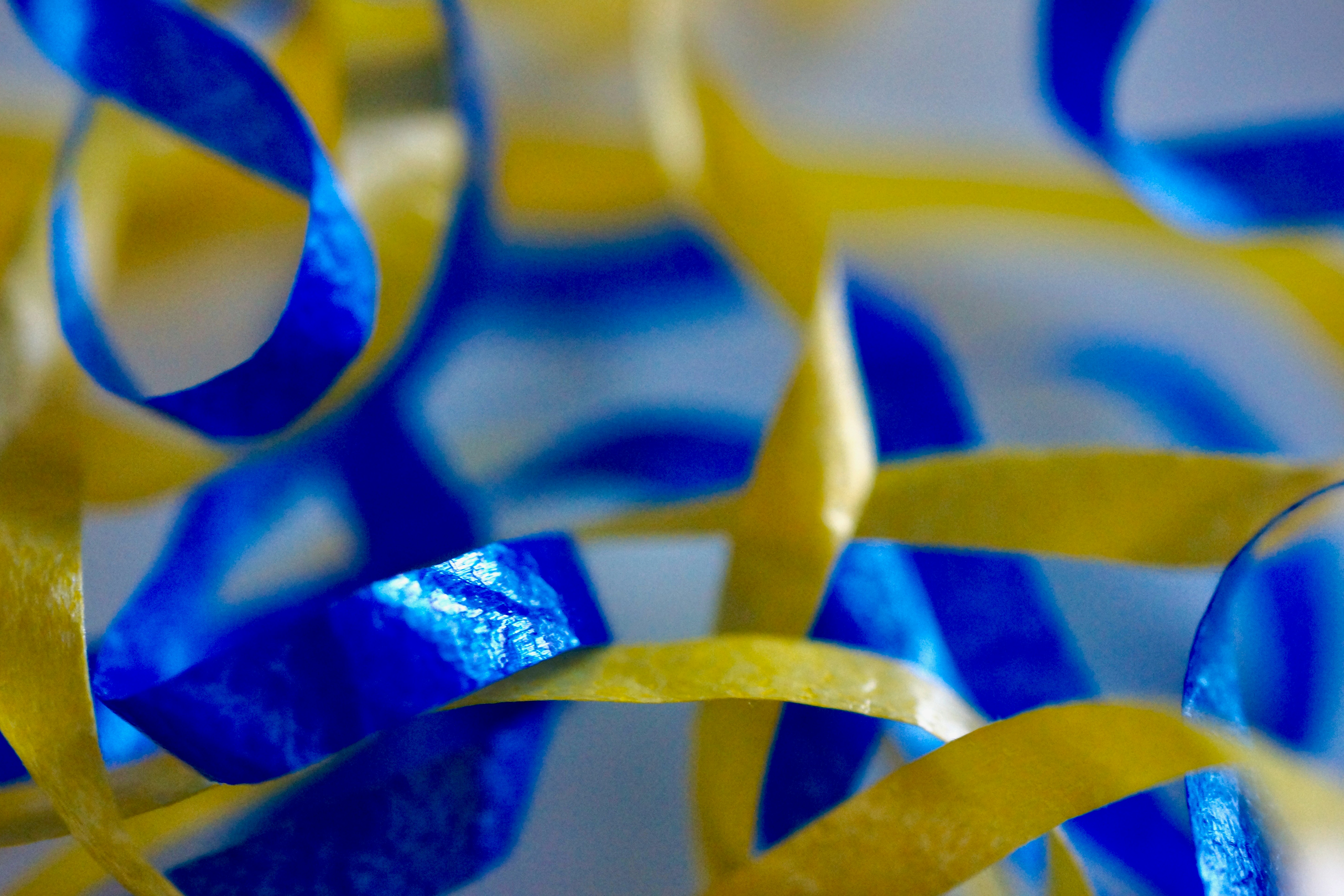 A bunch of blue and yellow streamers on a table photo – Free Art Image ...