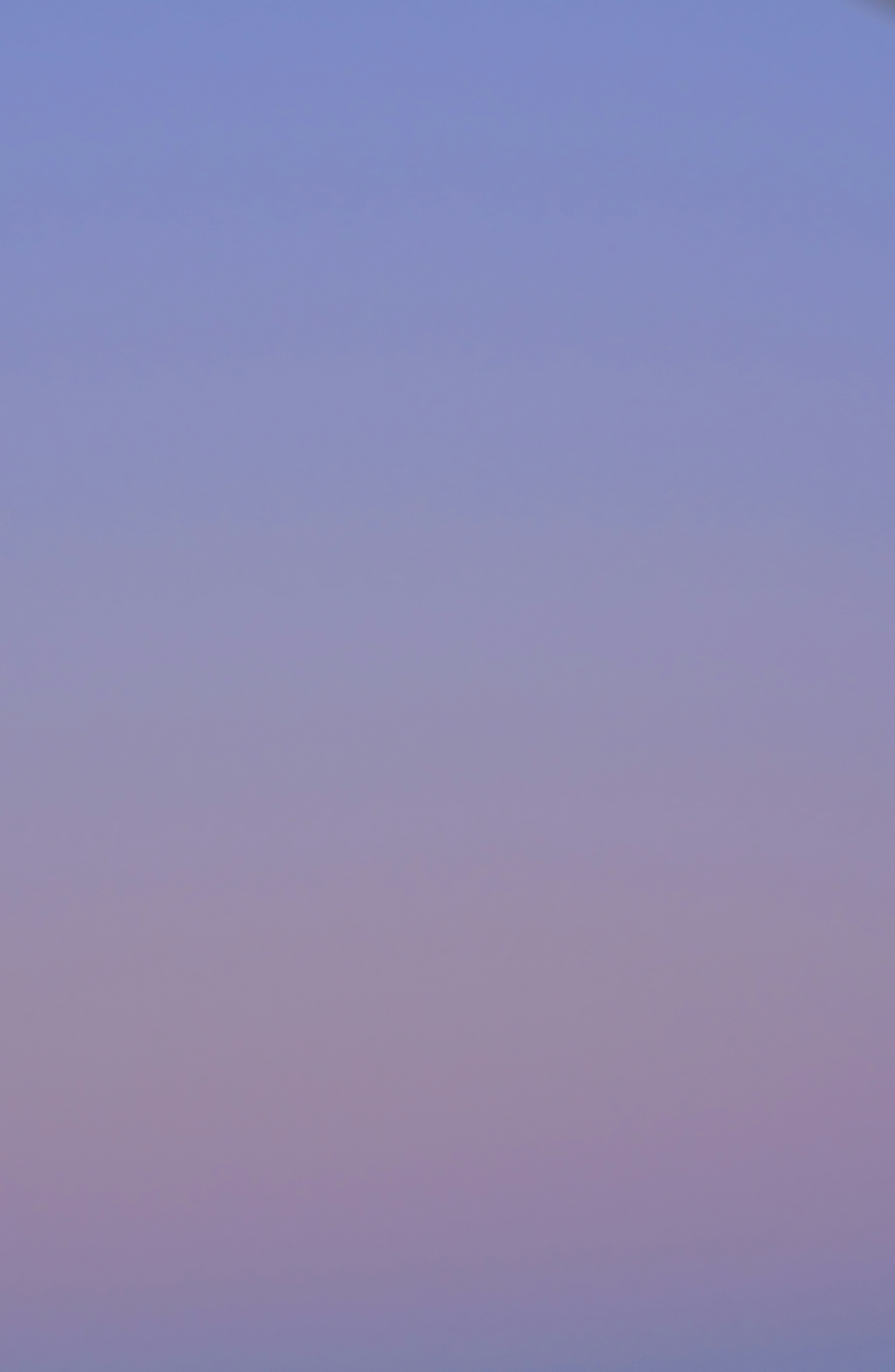 A serene gradient of soft purple and blue tones in the evening sky, evoking a sense of calm. Ideal for background use or atmospheric settings.