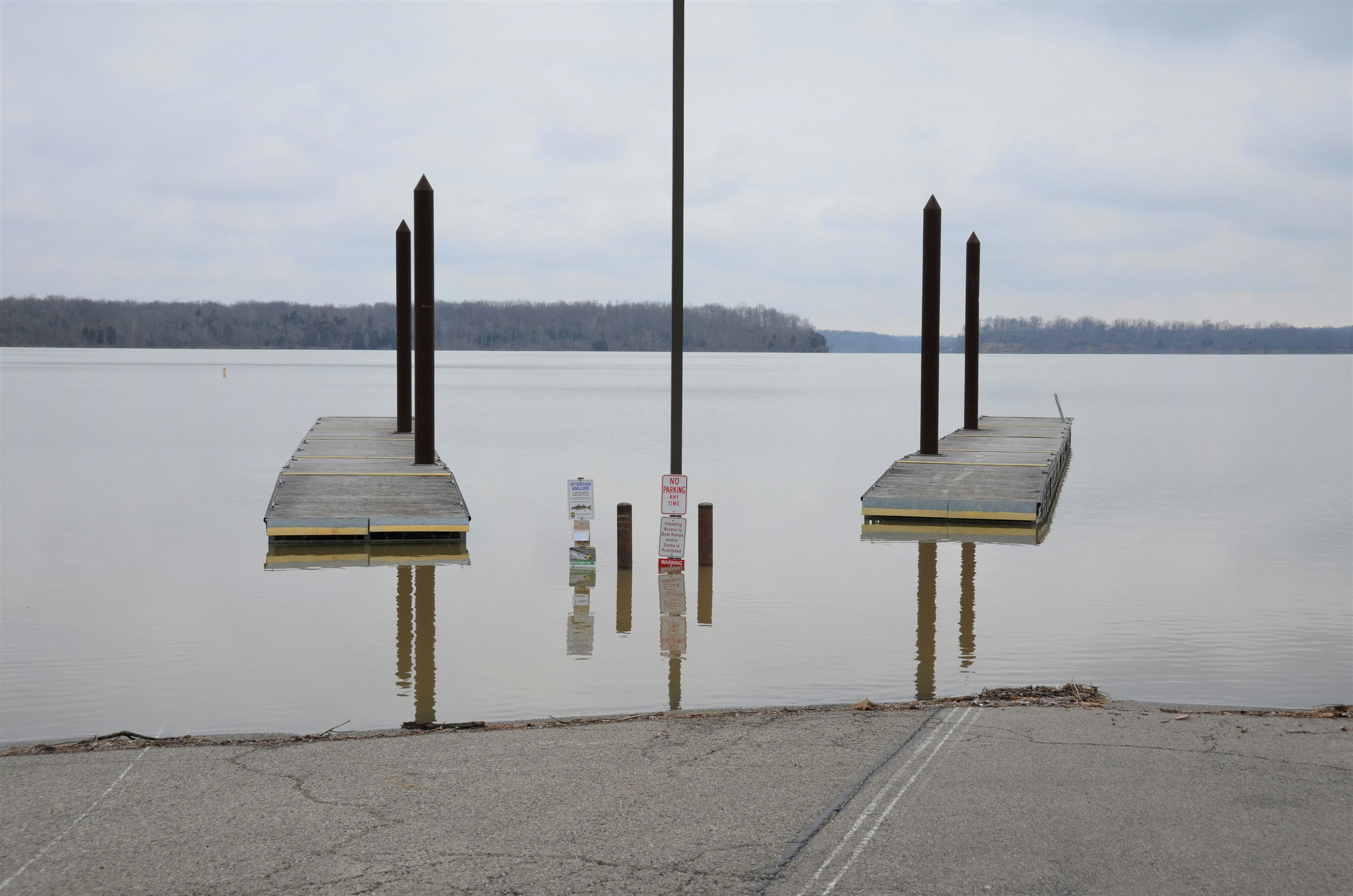Centerline of Stillness: A Lone Dock Reaches Across a Glassy Lake