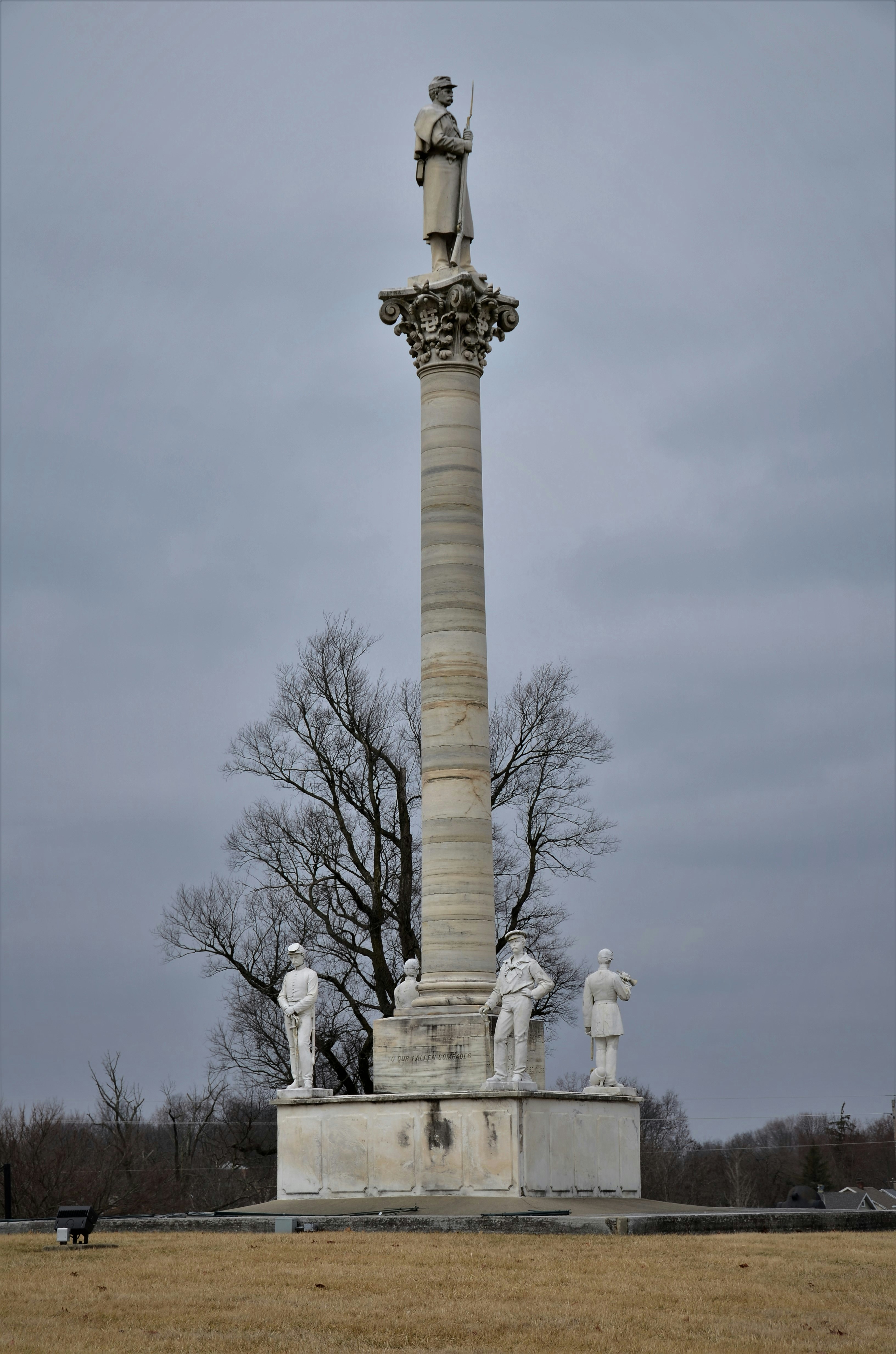 The Sentinel Column: Stone Guardians Beneath a Slate Sky