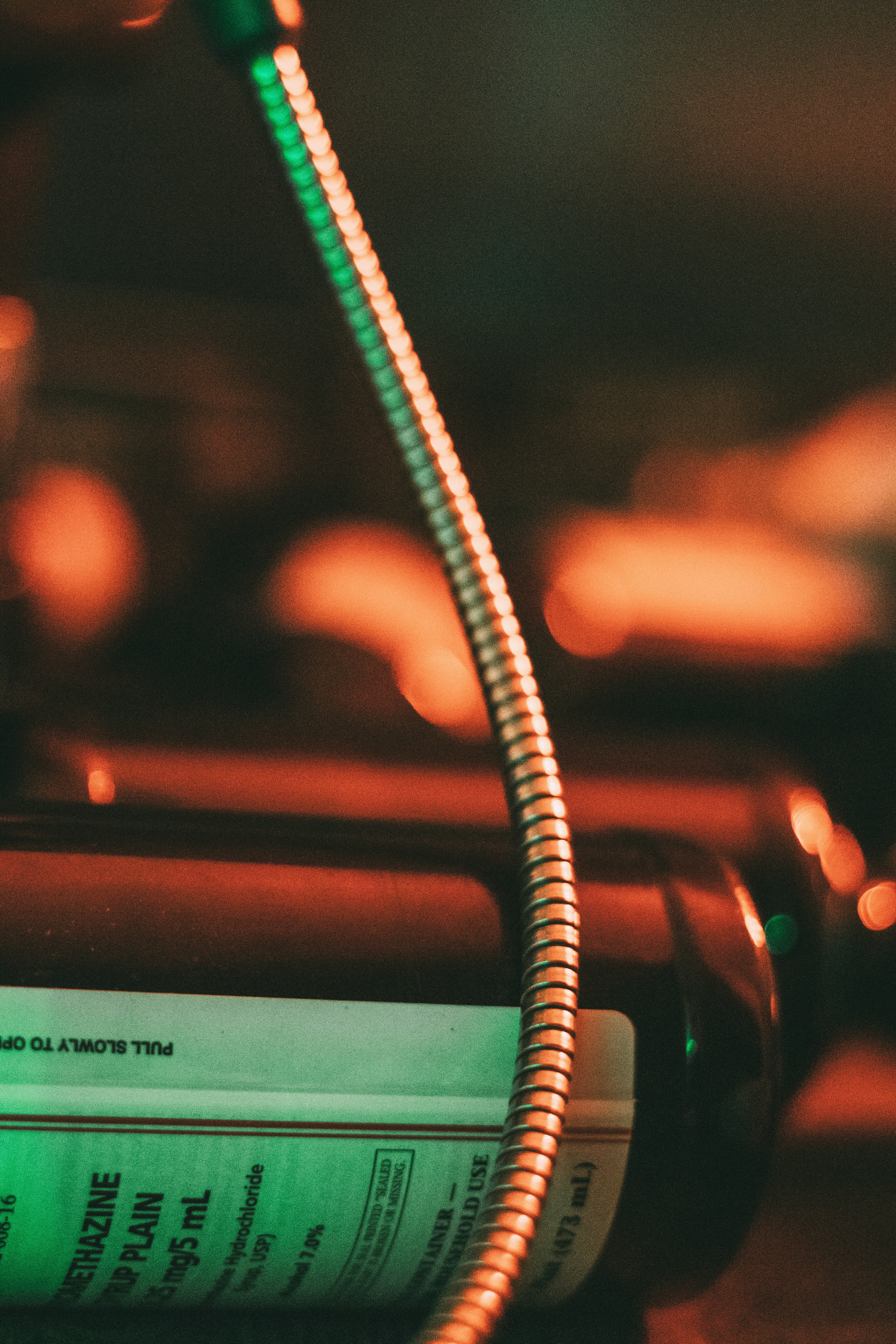 Neon-Coiled Cylinder in a Dim Medical Subtone