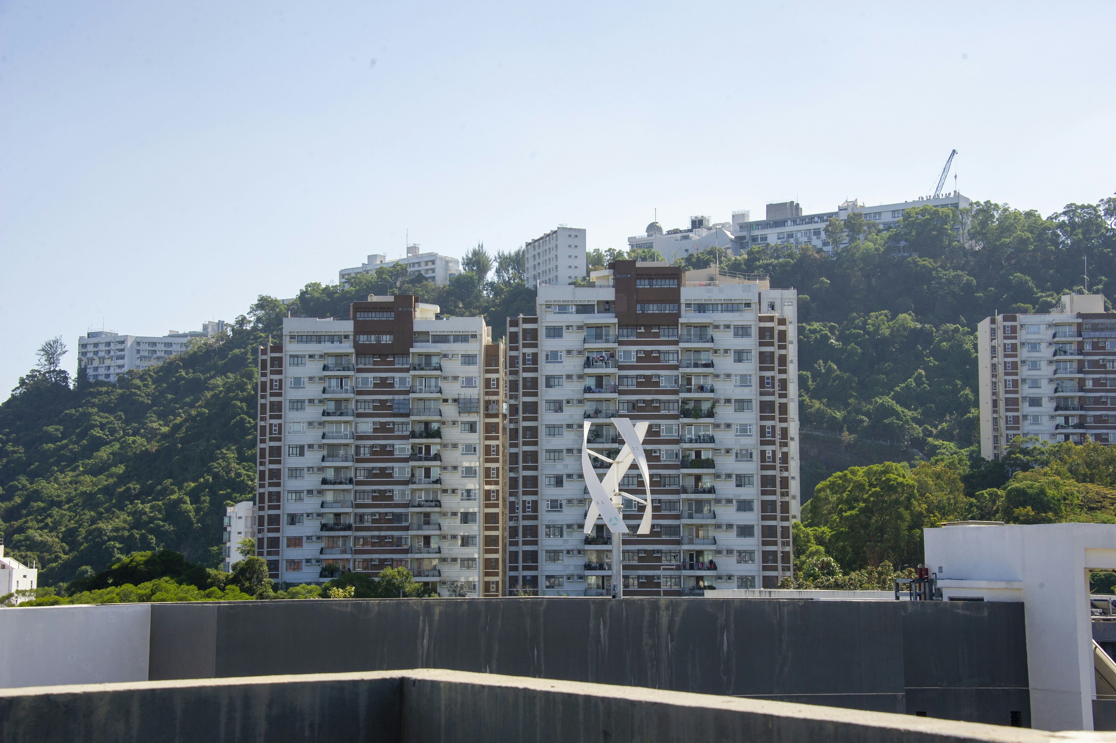 Mid-Century Towers Framed by a Sculptural Monument