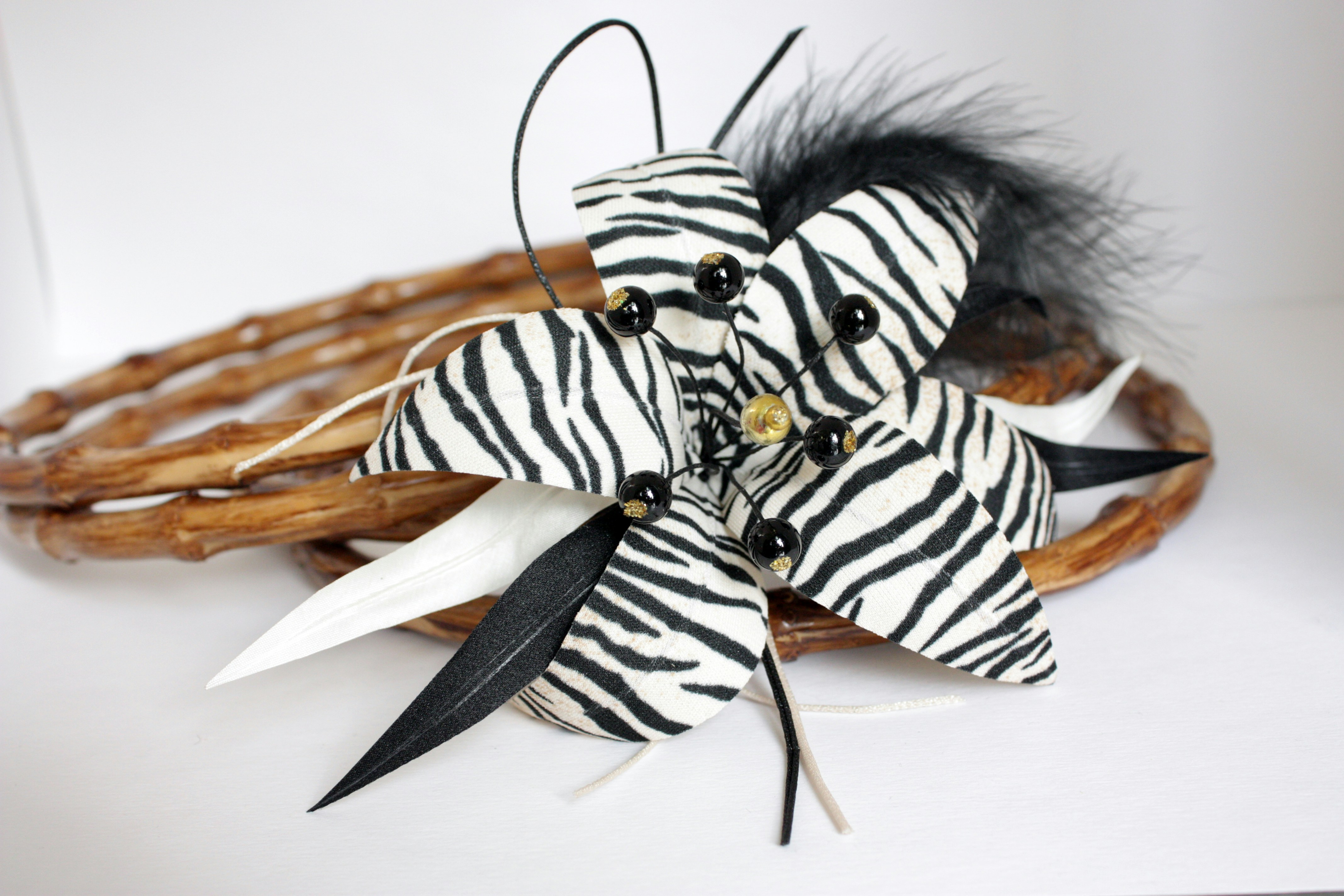 Zebra-striped boutonniere resting on a woven nest, with black accents