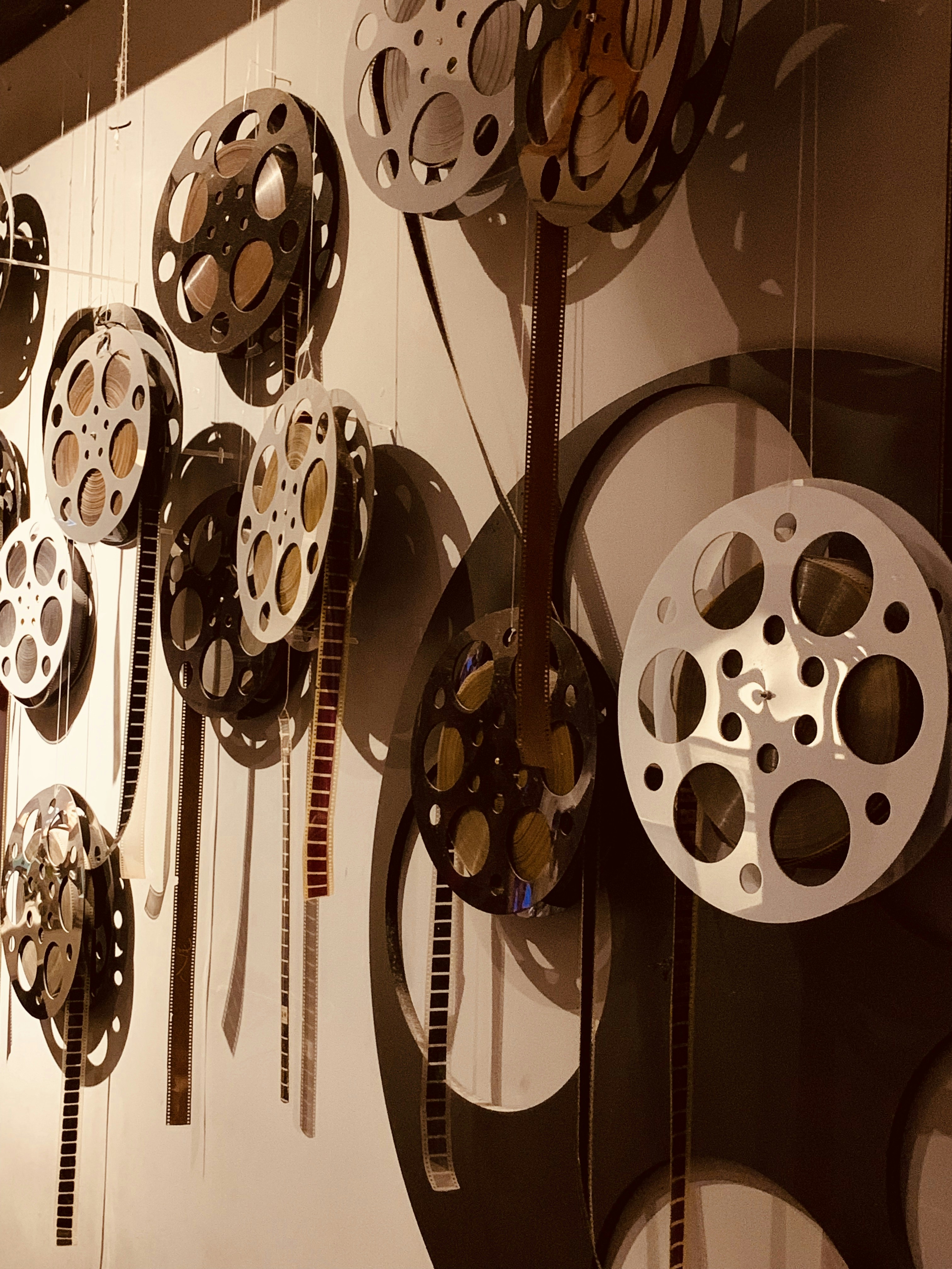 A bunch of clocks that are hanging on a wall photo – Free Reel Image on ...