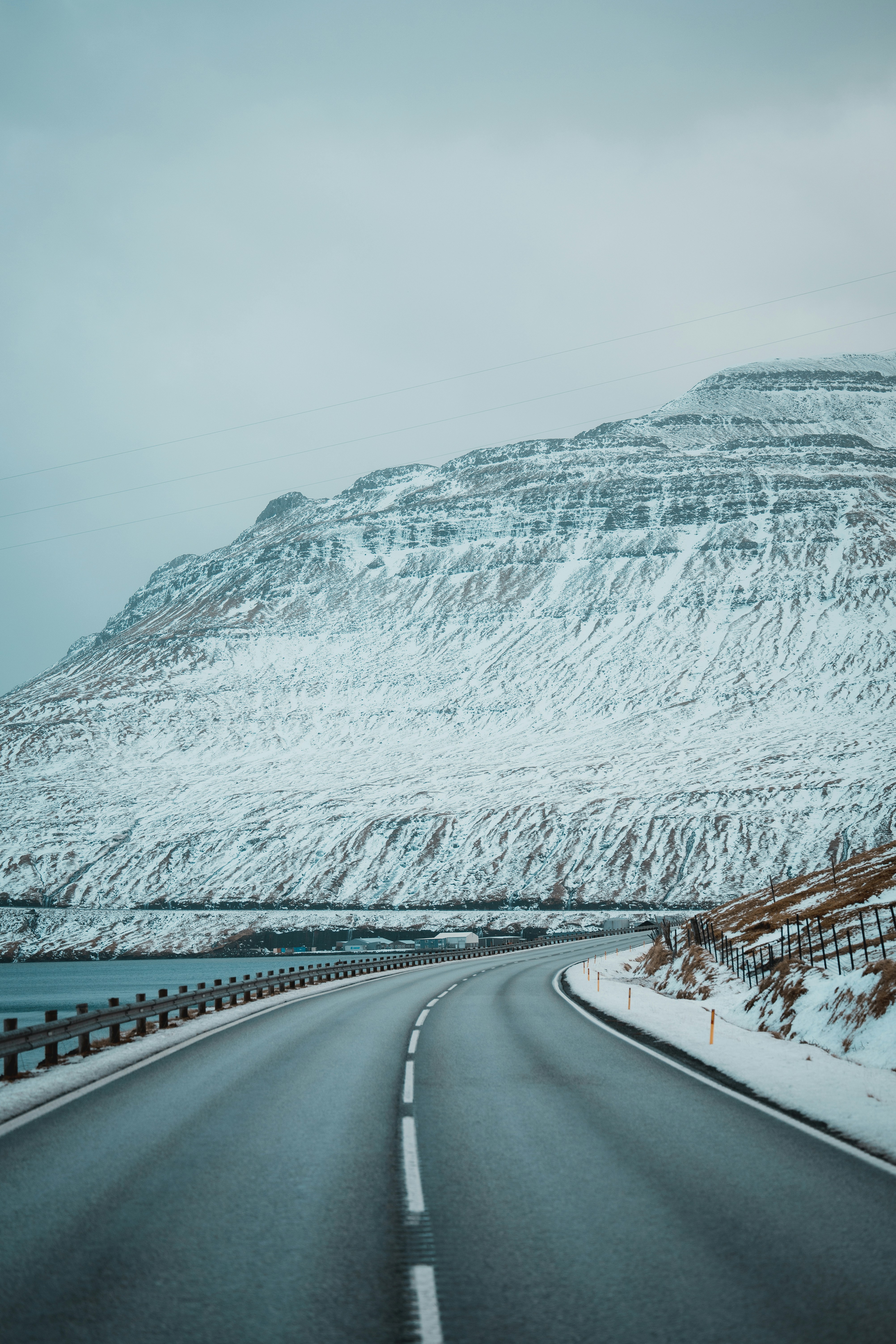 Snow-Crowned Highway: A Mountain Pass Bends Toward Winter Silence