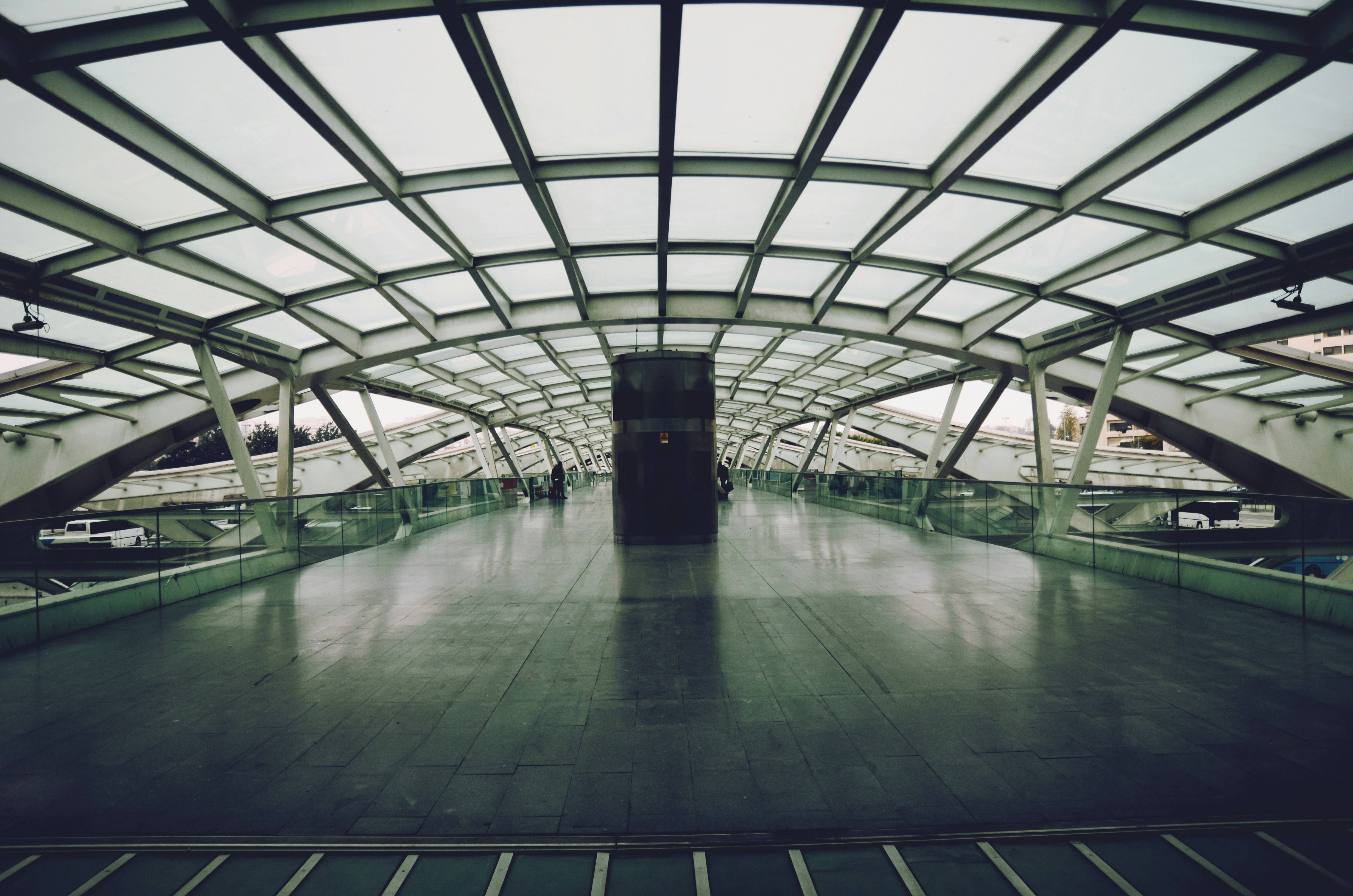 A walkway inside of a building with lots of windows photo – Free ...