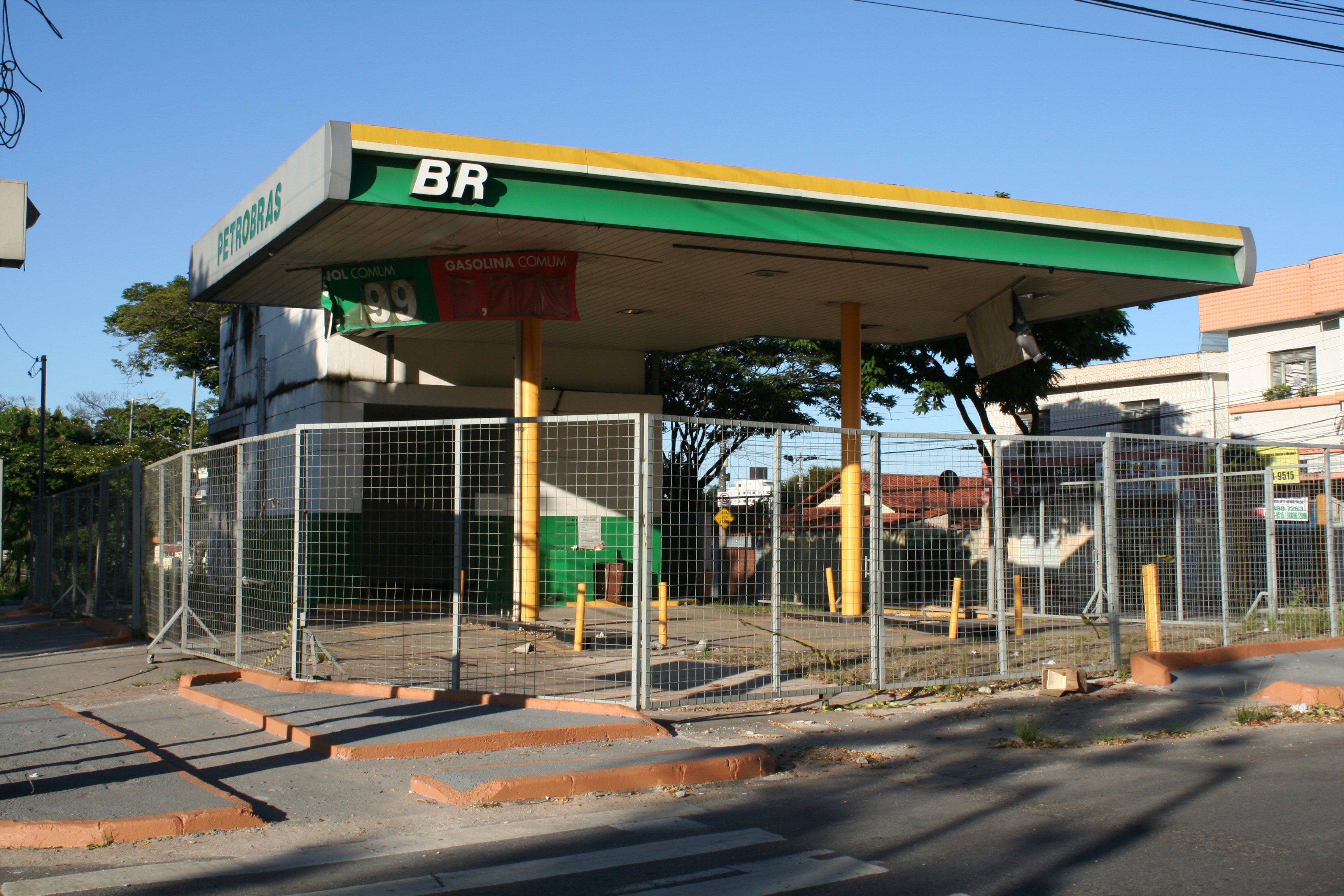 A green and yellow gas station sitting on the side of a road photo ...