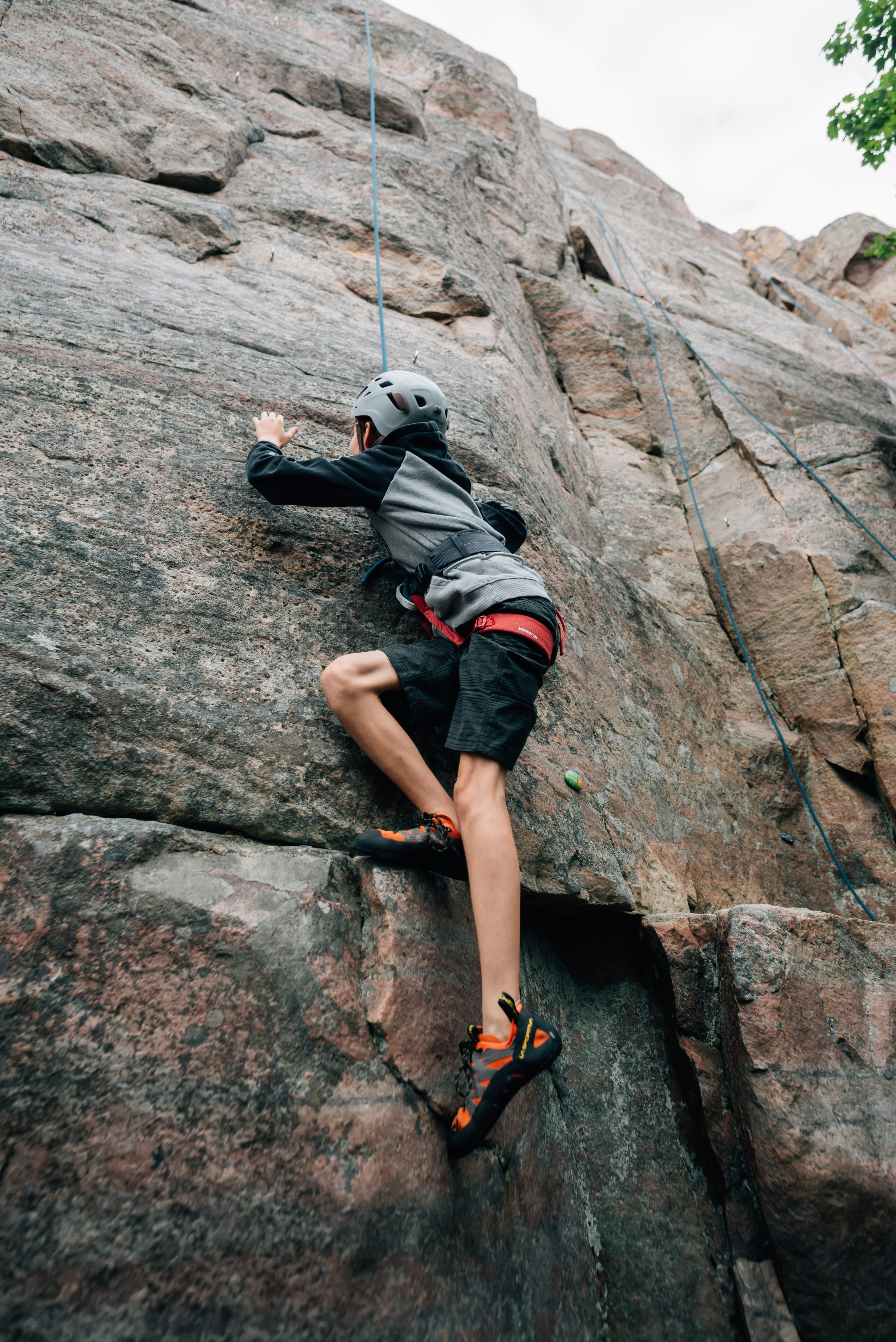 Climber in mid-ascent: a kez of grit and ascent