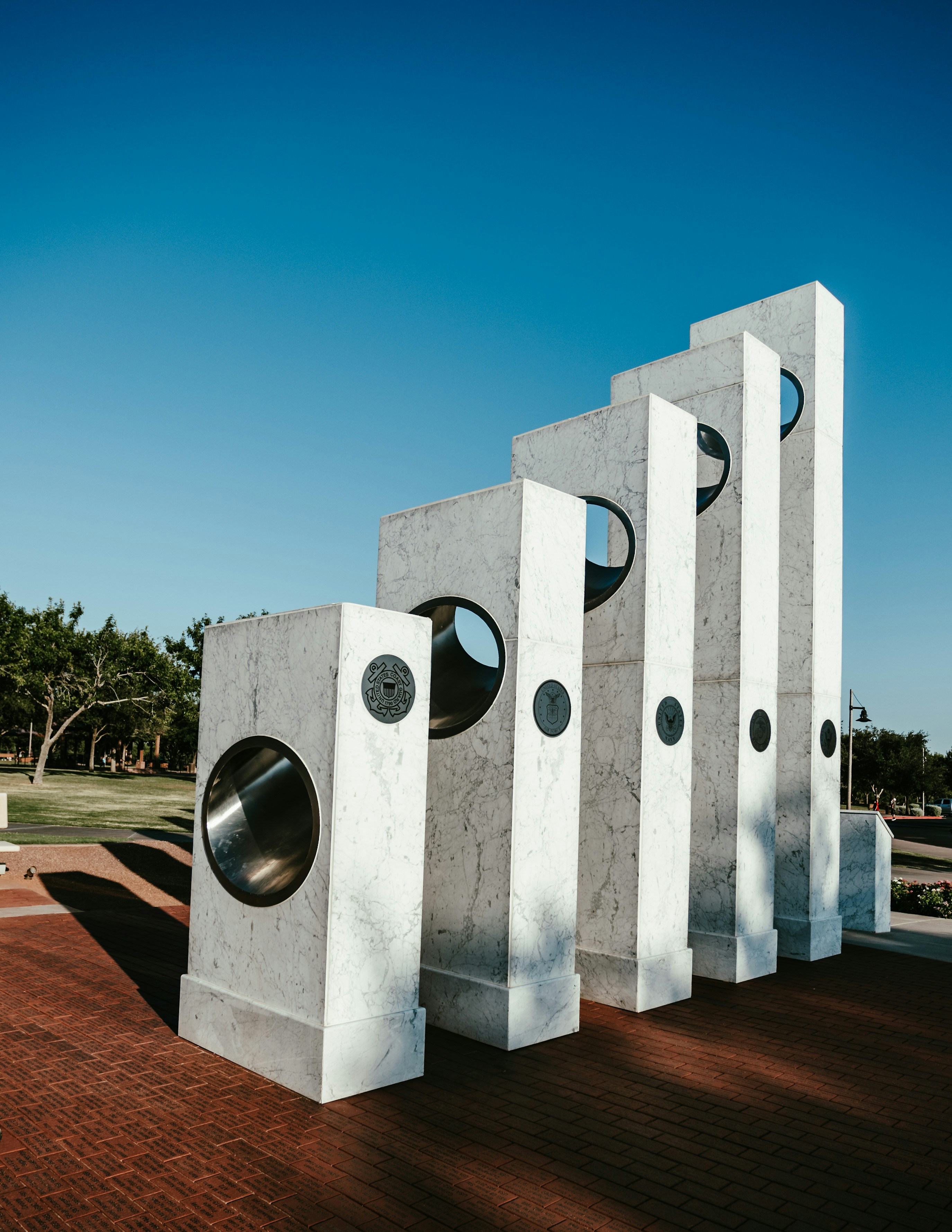 A group of cement sculptures sitting next to each other photo – Free ...