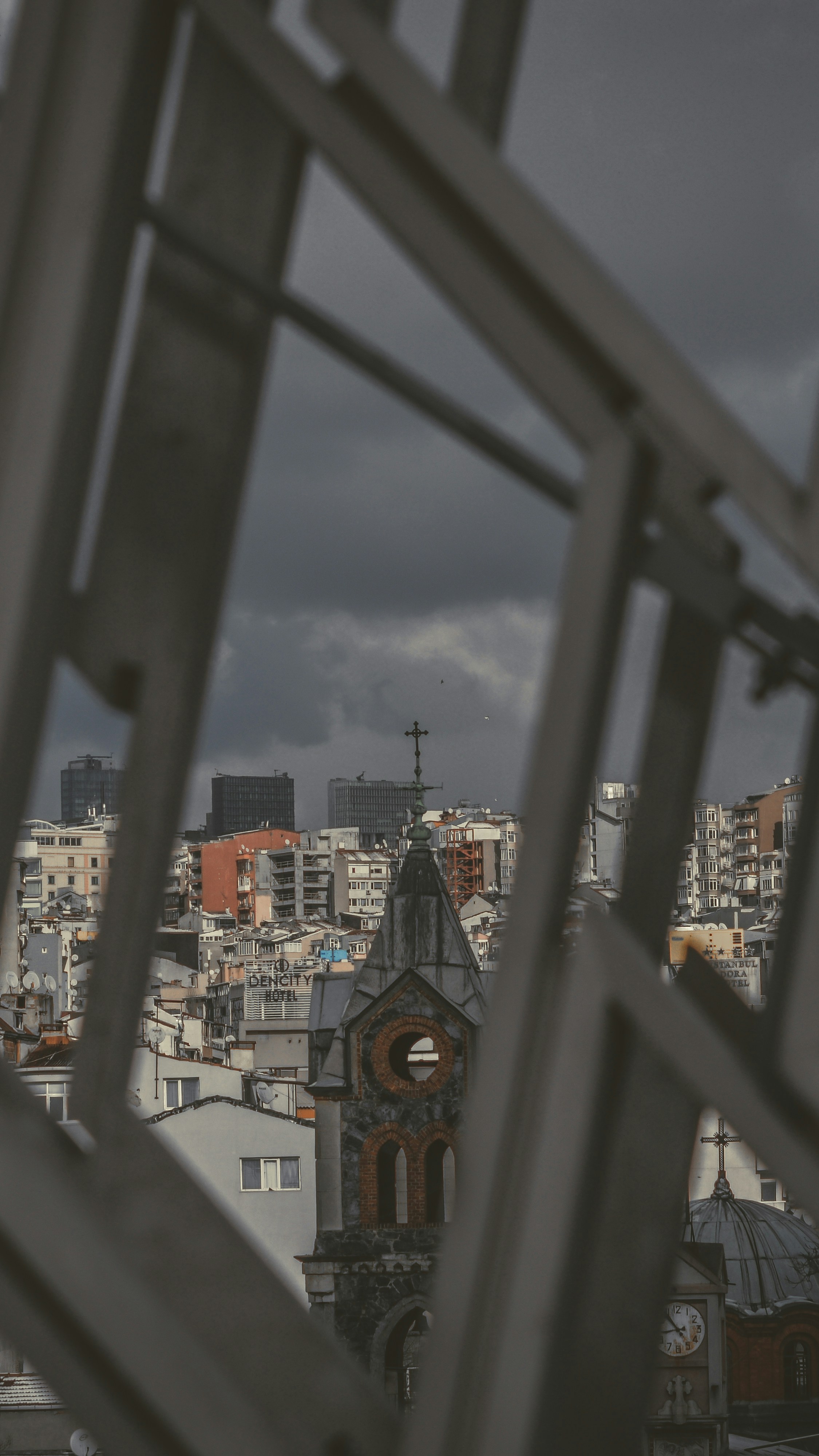 A view of a clock tower through a window photo – Free Nature Image on ...