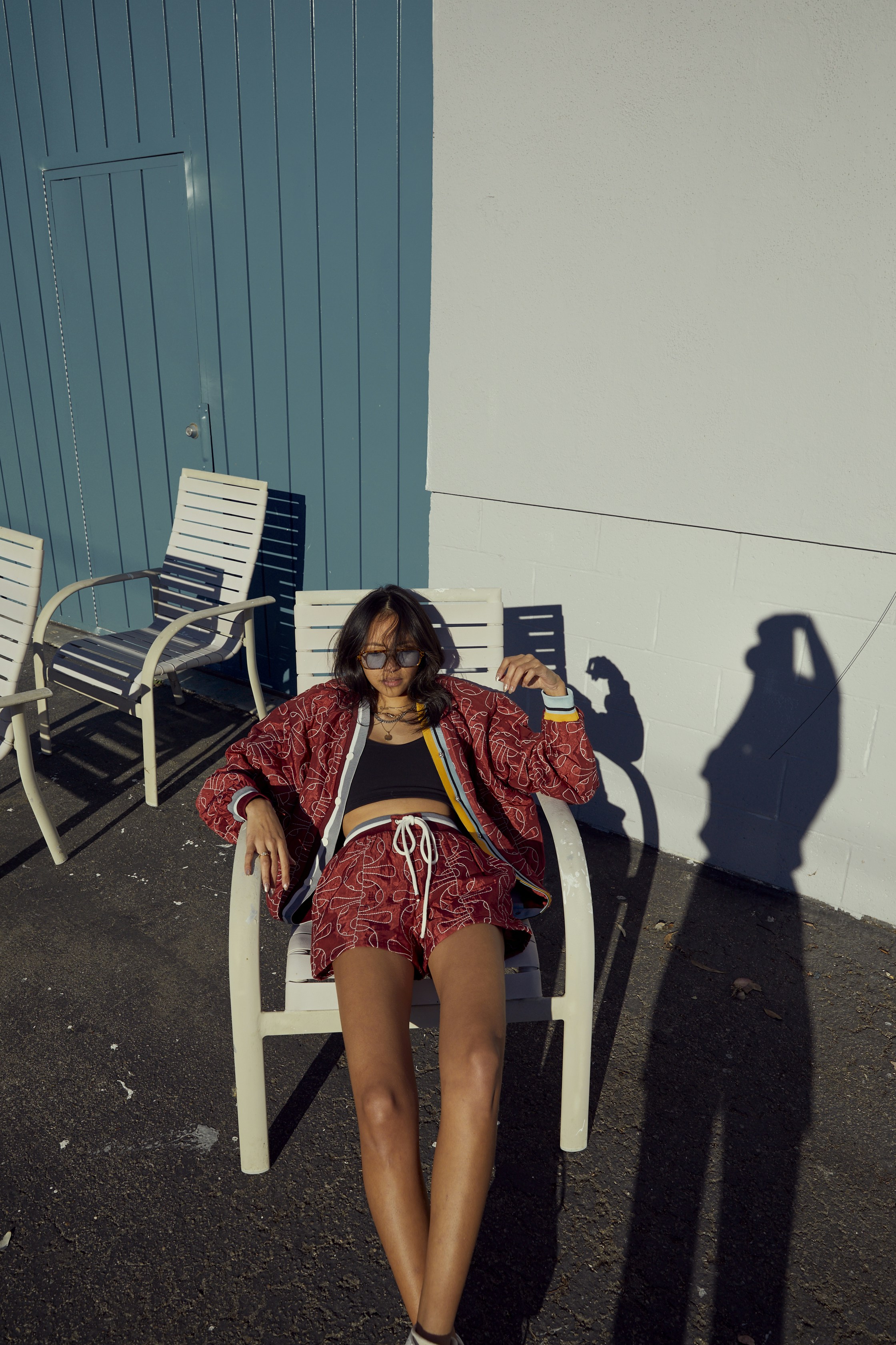 A woman sitting in a chair with her shadow on the wall photo – Free ...