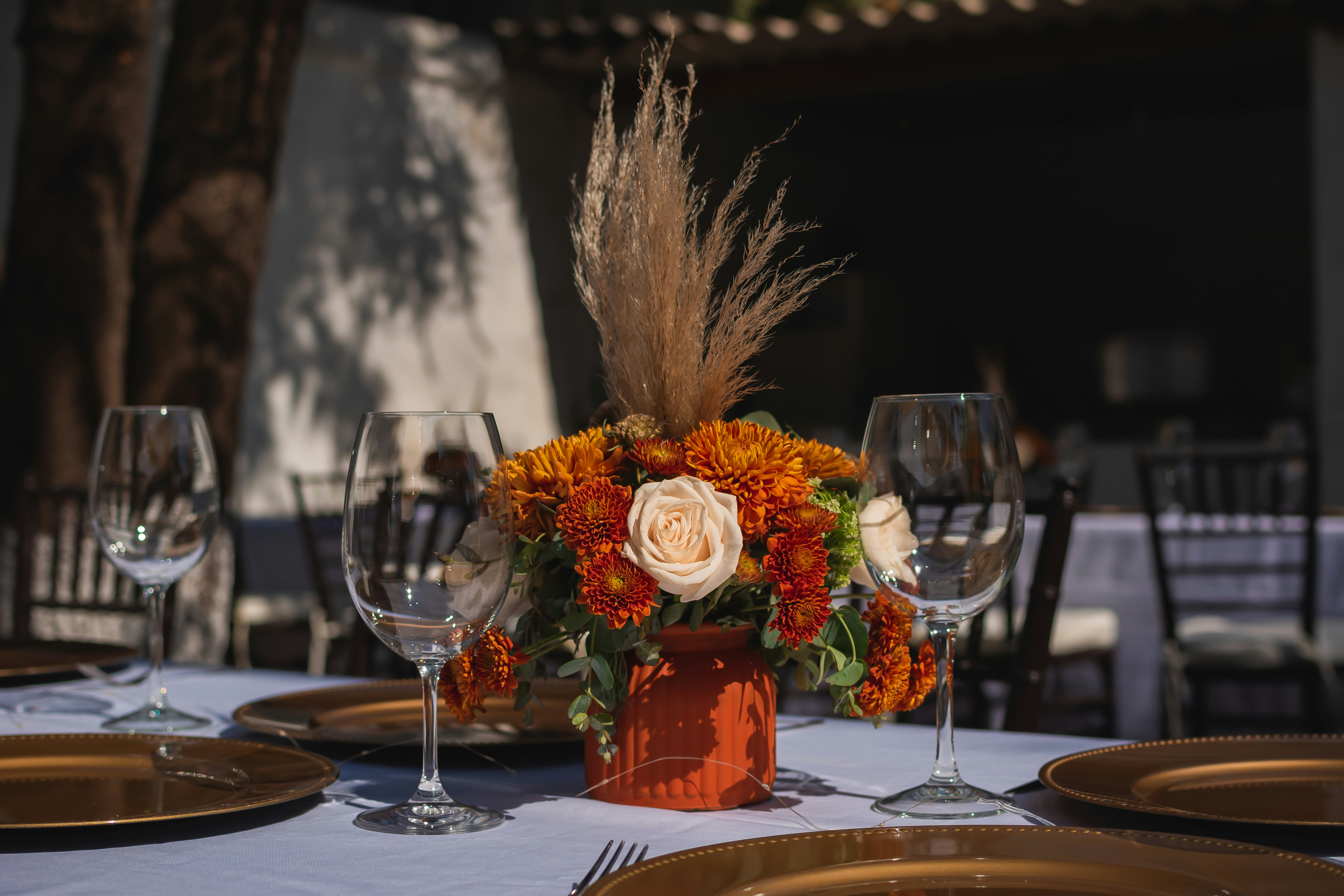 Pampas and Orange Bloom Centerpiece on a Sunlit Outdoor Table