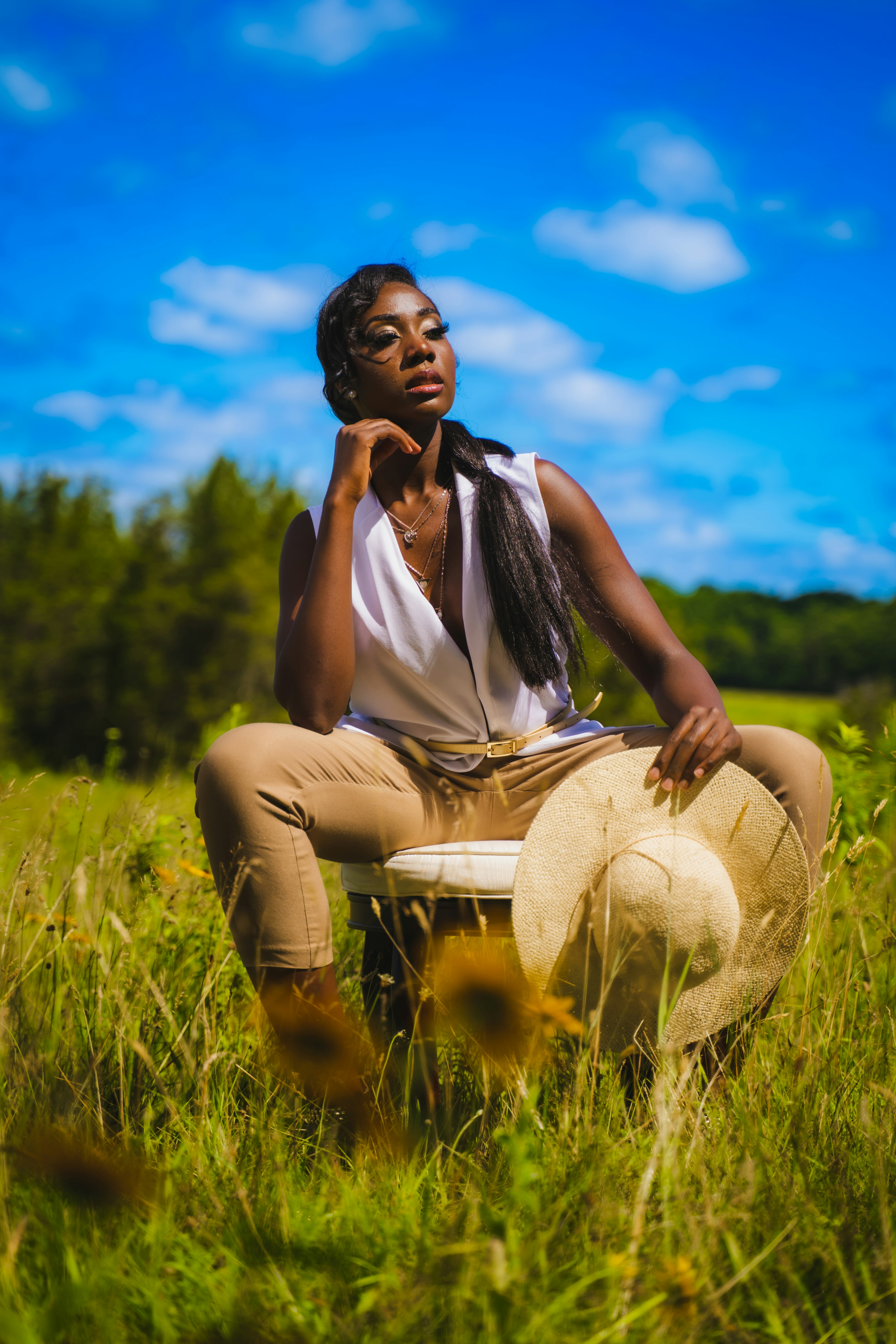 Sunlit Solace: Portrait in a Meadow Under a Cerulean Sky