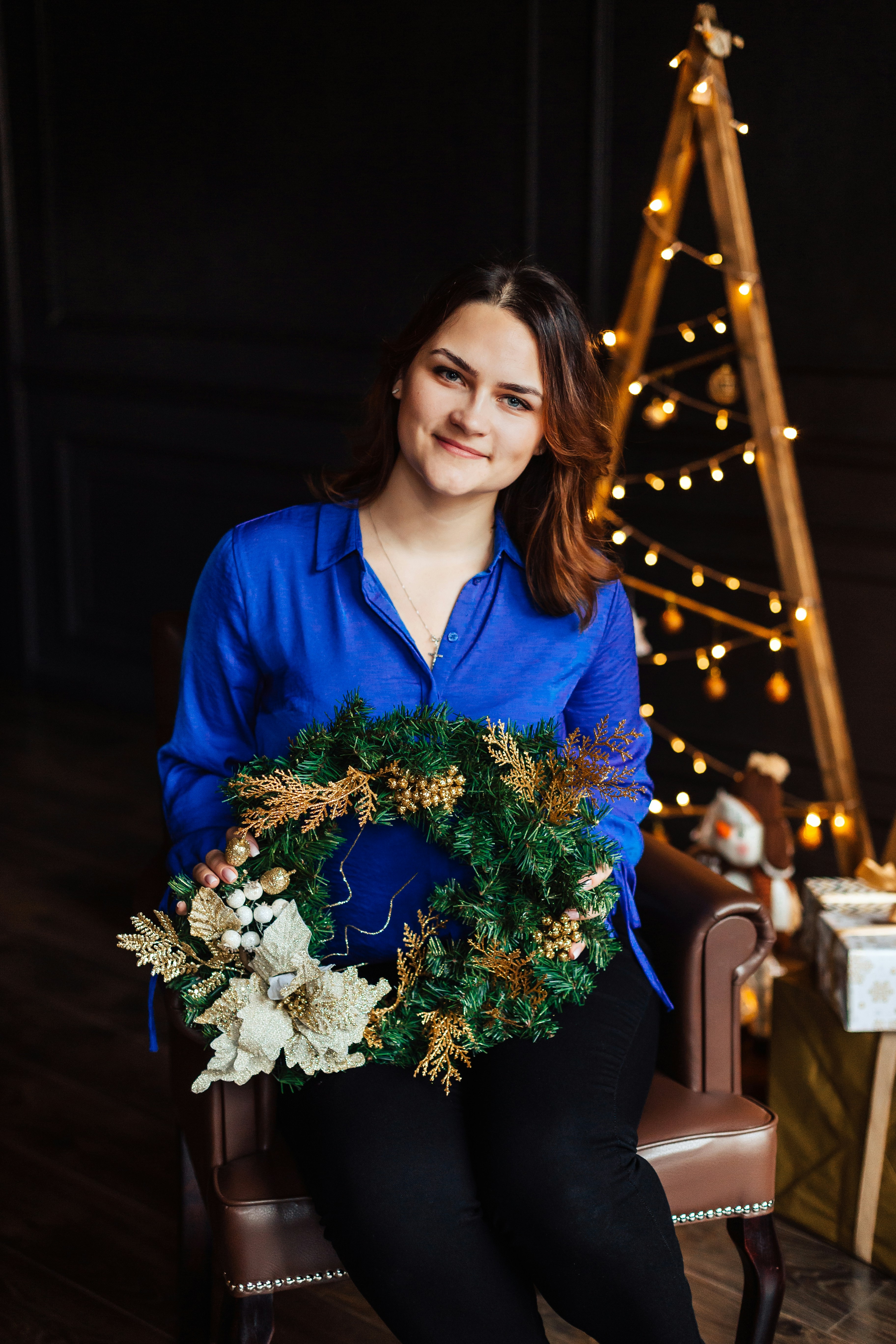 Blue Blouse, Golden Glow: A Christmas Wreath Portrait by Fairy Lights