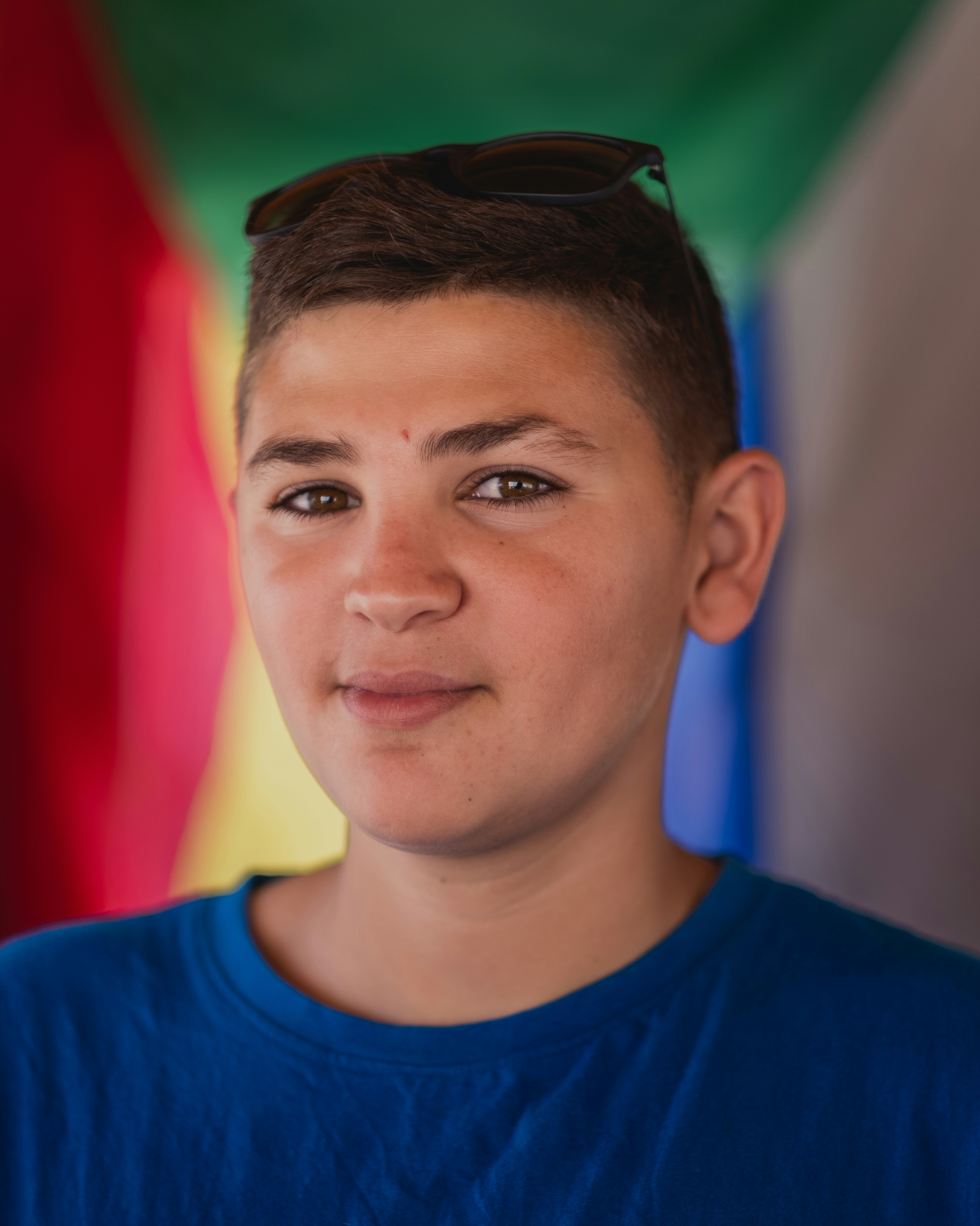 Prism-Soft Portrait: A Quiet Look Beneath the Rainbow Backdrop
