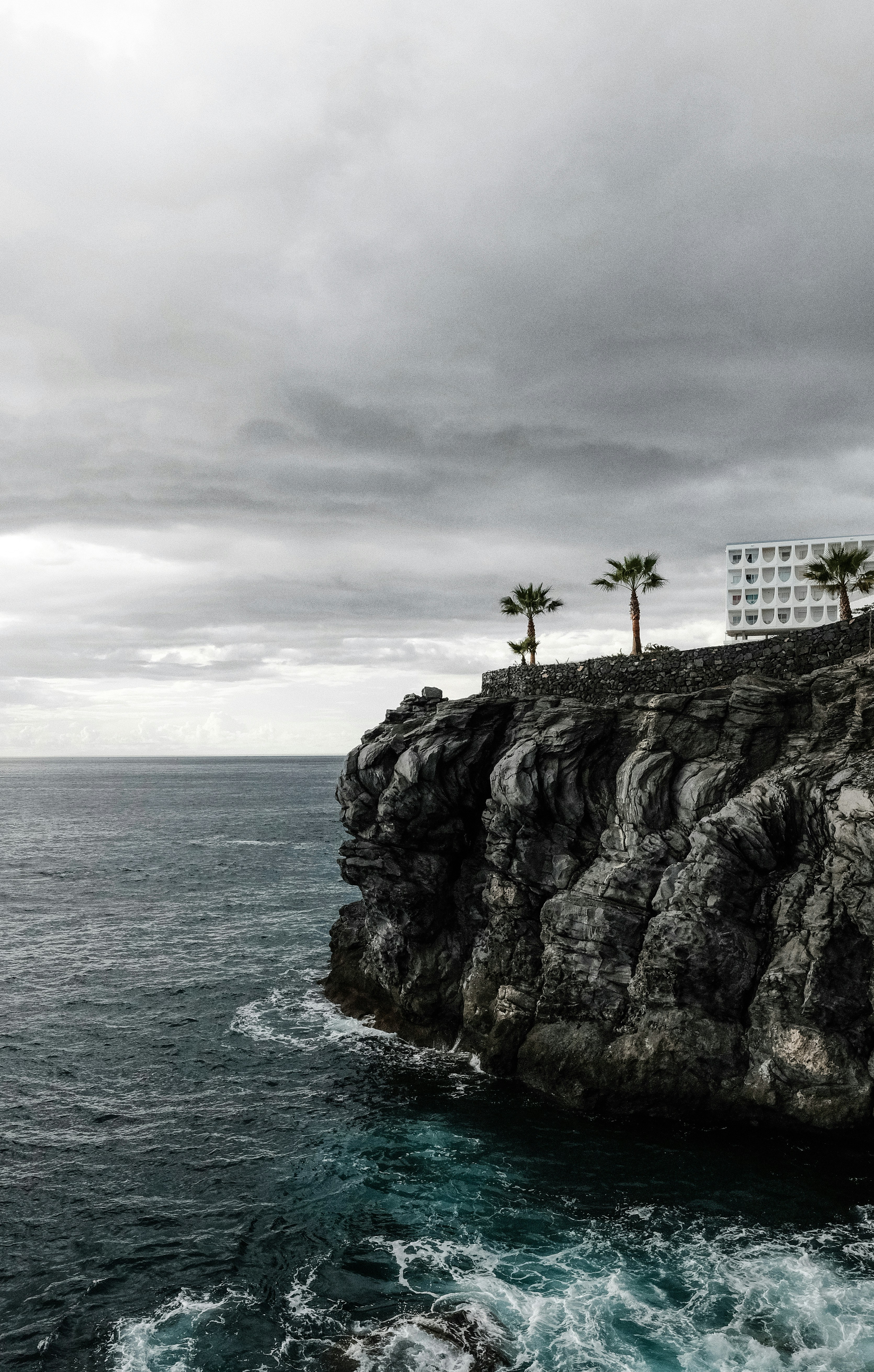 Cliffside Palms and a Geometric Hotel Over the Sea