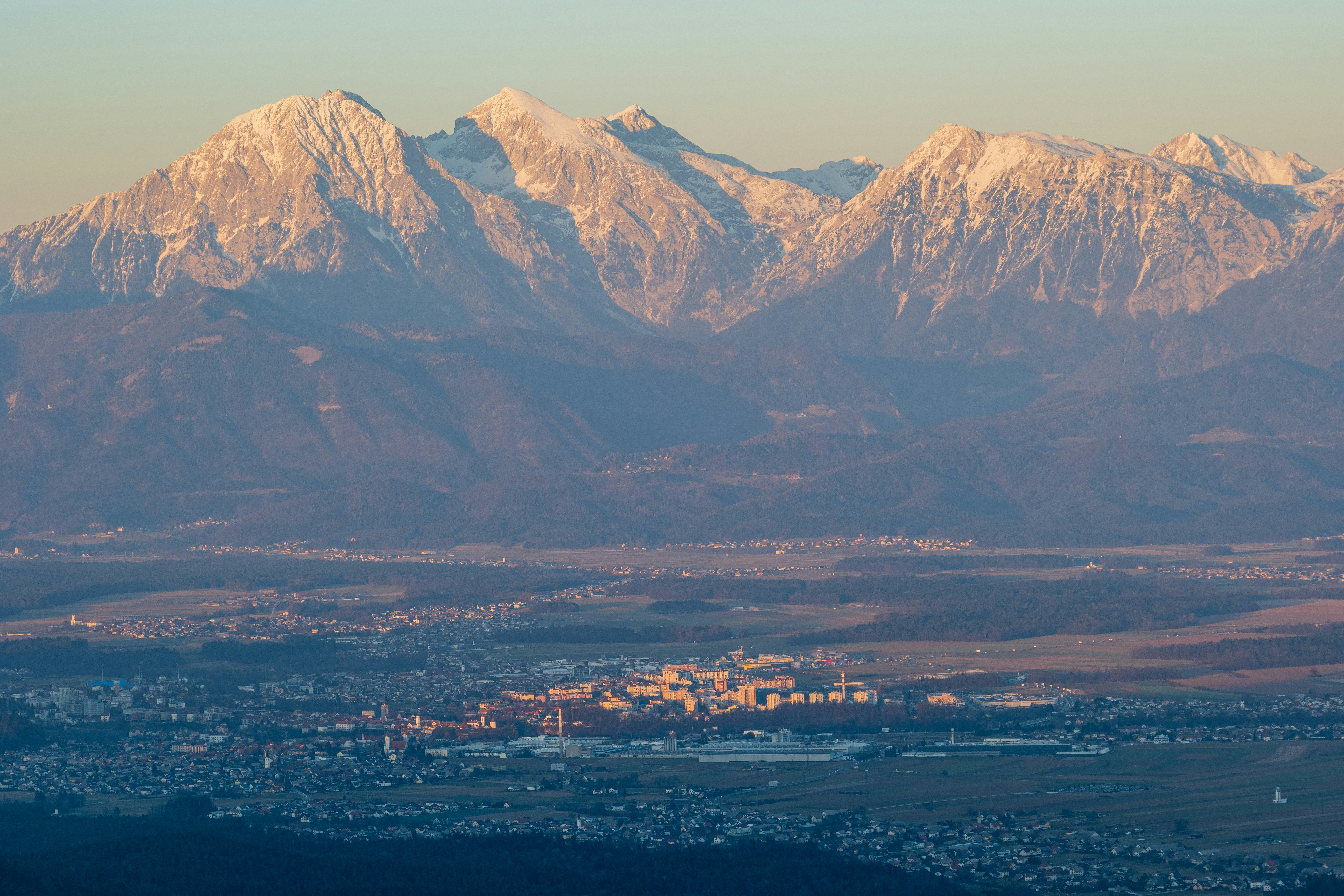 Snow-dusted Peaks Over a Quiet Valley Town at Dusk