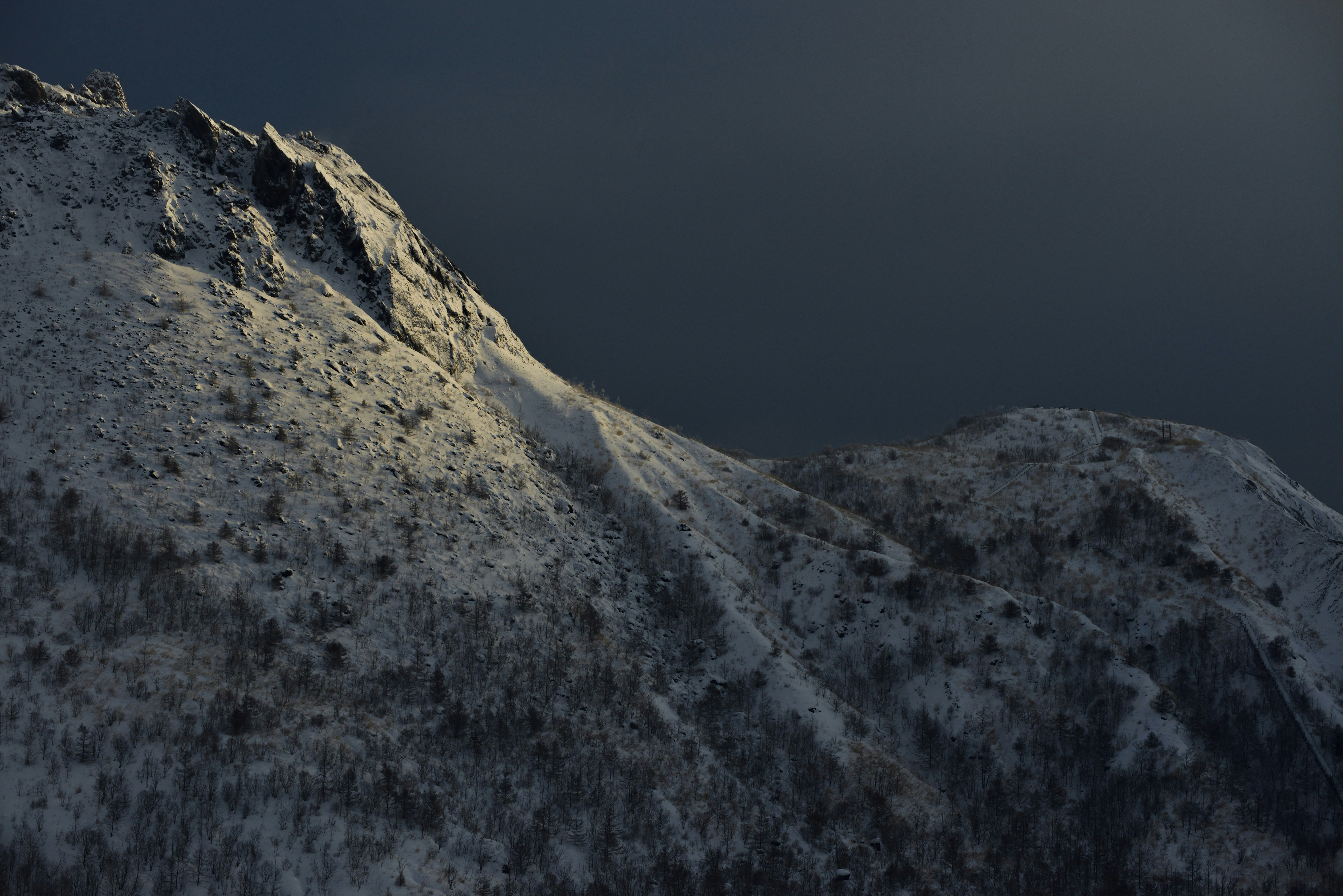 Blue Hour Ridge: Snowbound Prominence Against a Looming Sky