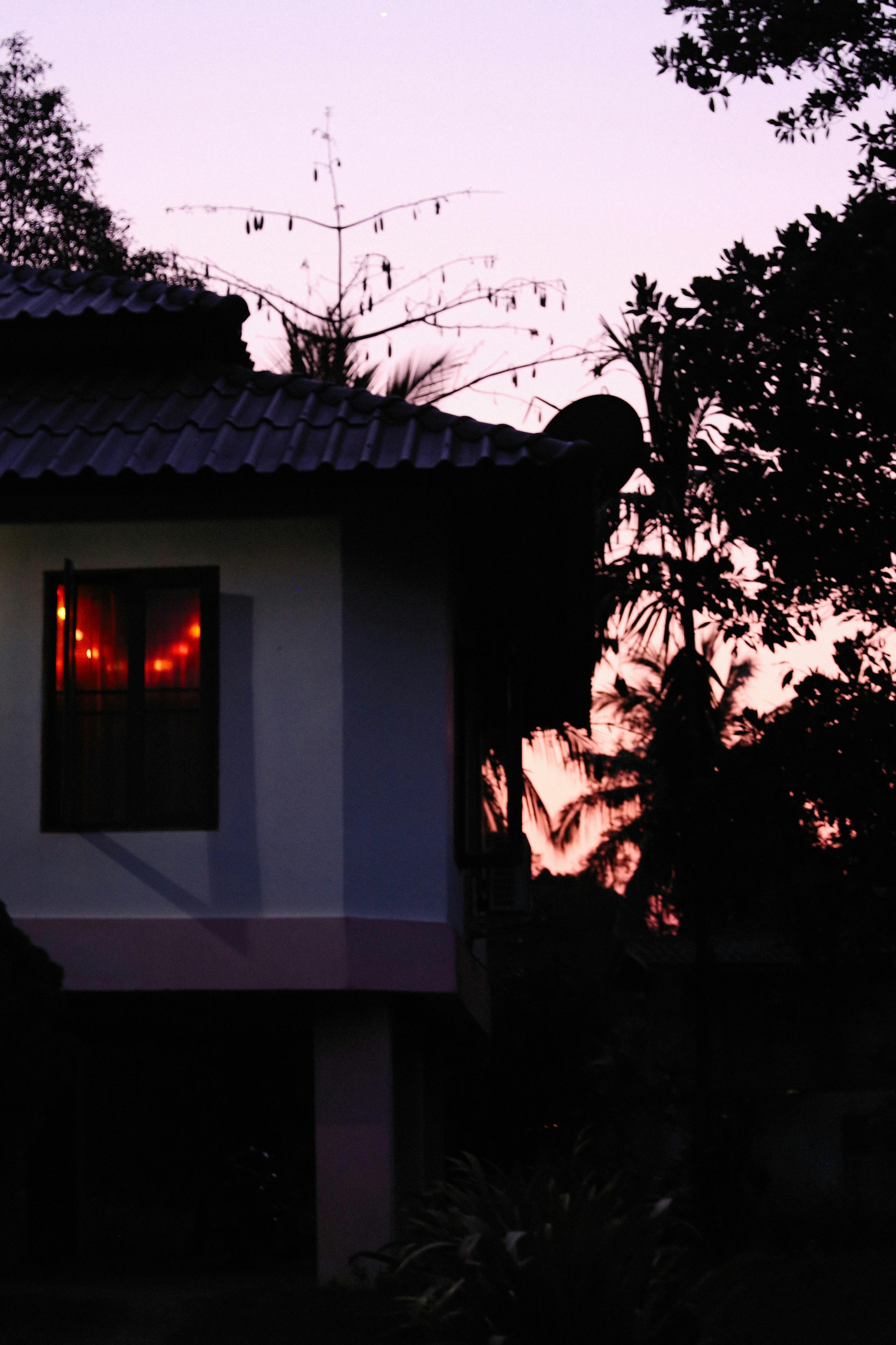 Crimson Window Aglow Against a Dusky Silhouette