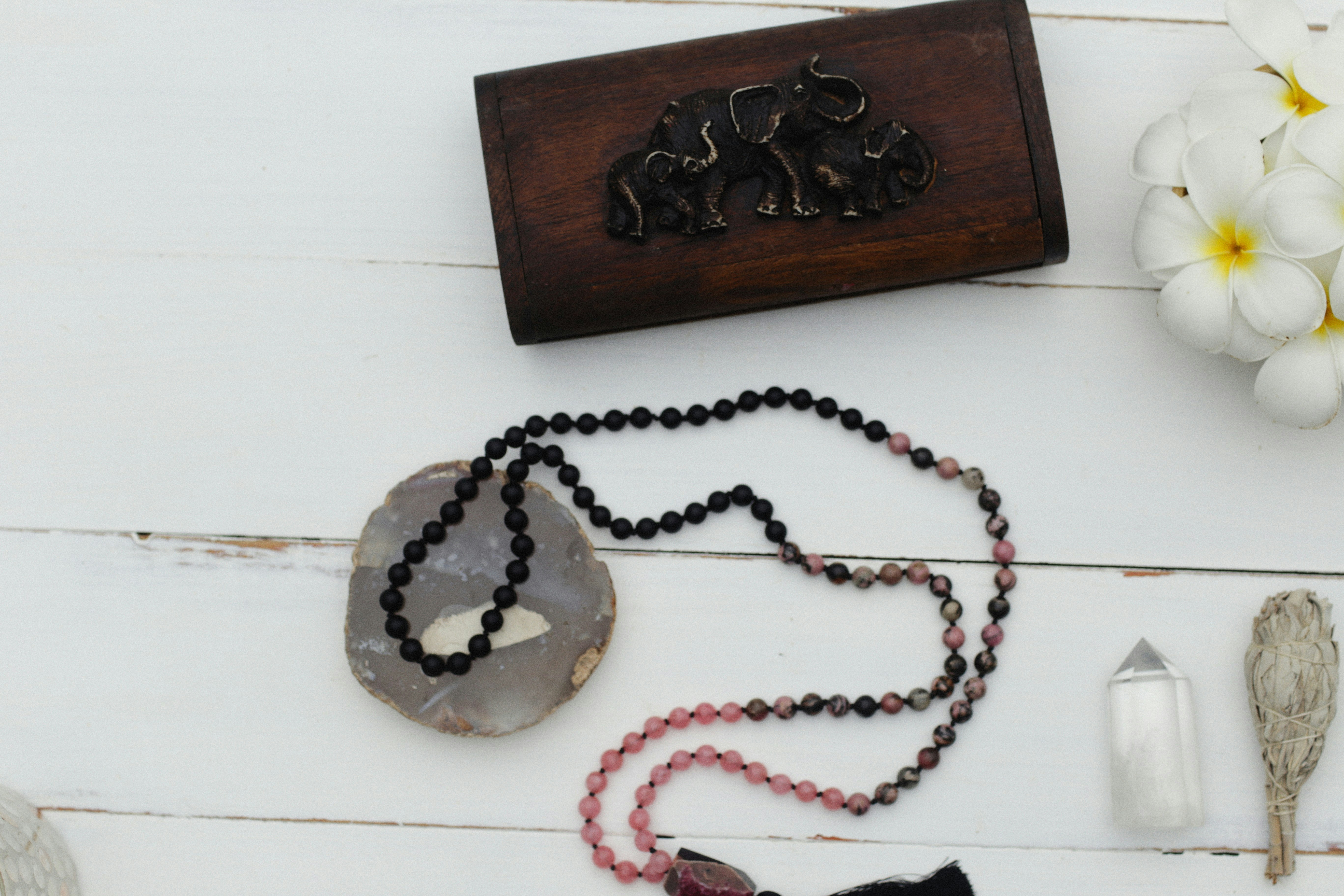 a wooden box with a necklace and other items