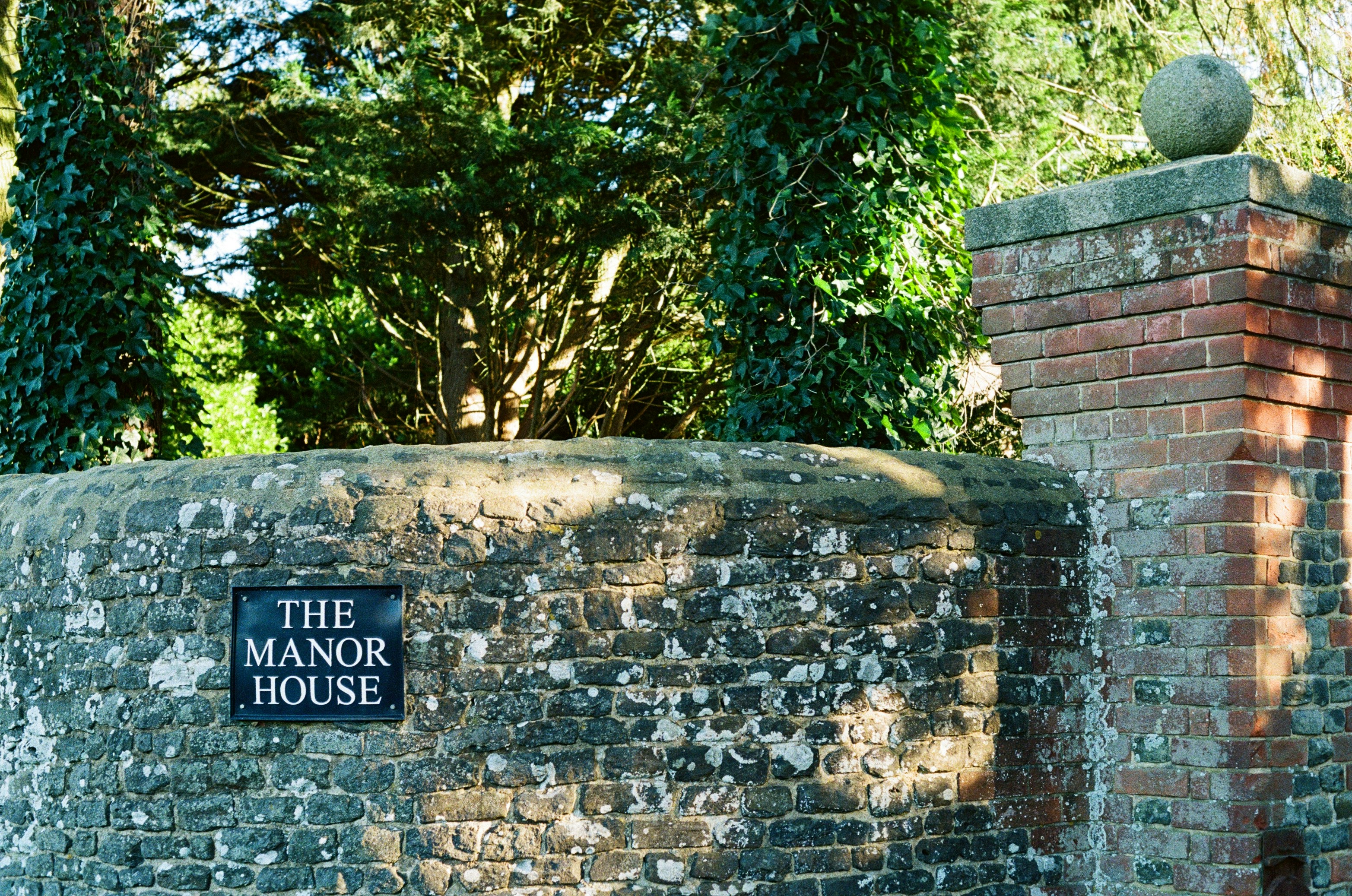 A brick wall with a sign that says the manor house photo – Free Farnham ...